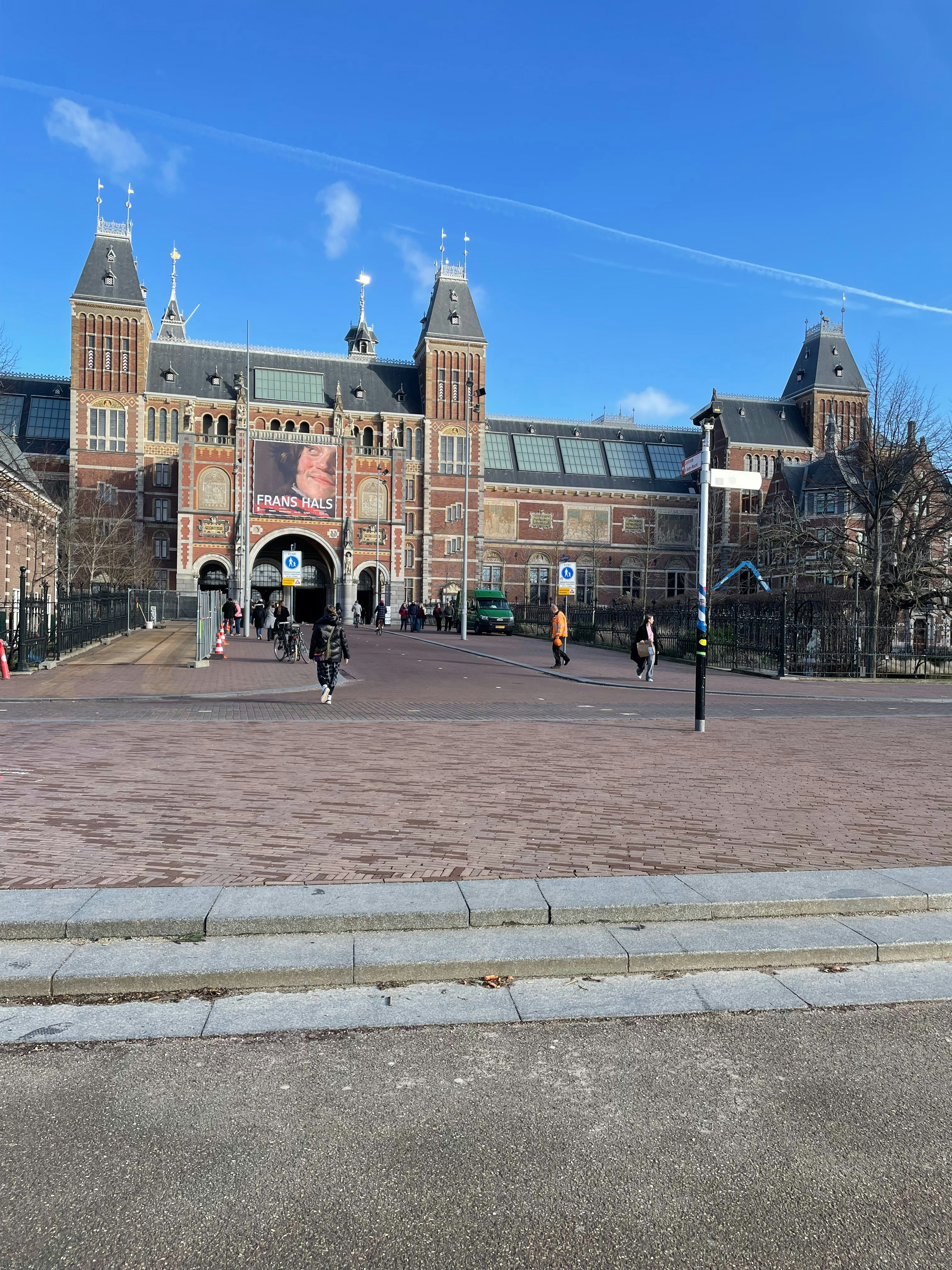 Gateway of Brick and Light: Pedestrians at the Central Arch of a Dutch Museum