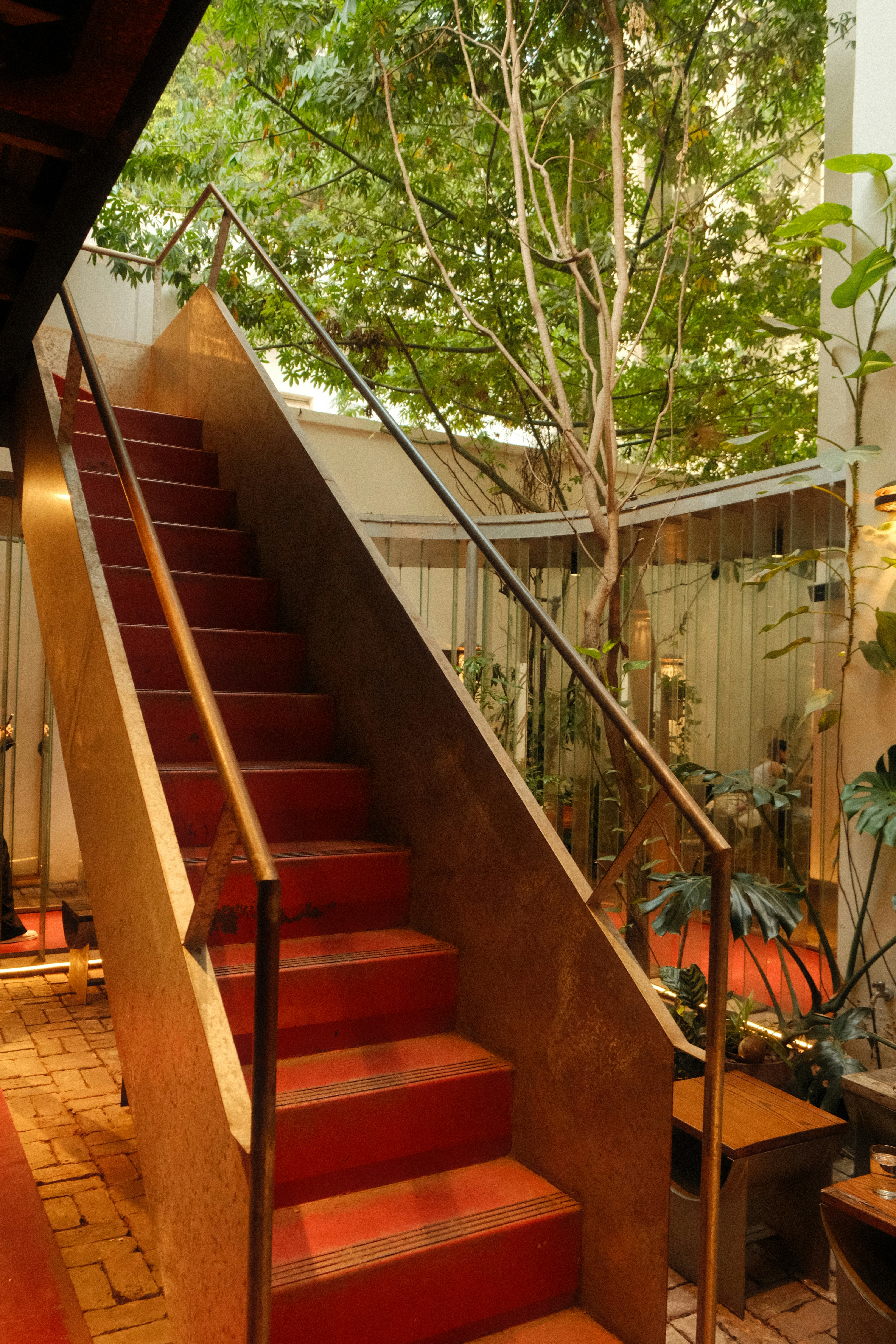 a set of red stairs leading up to a tree