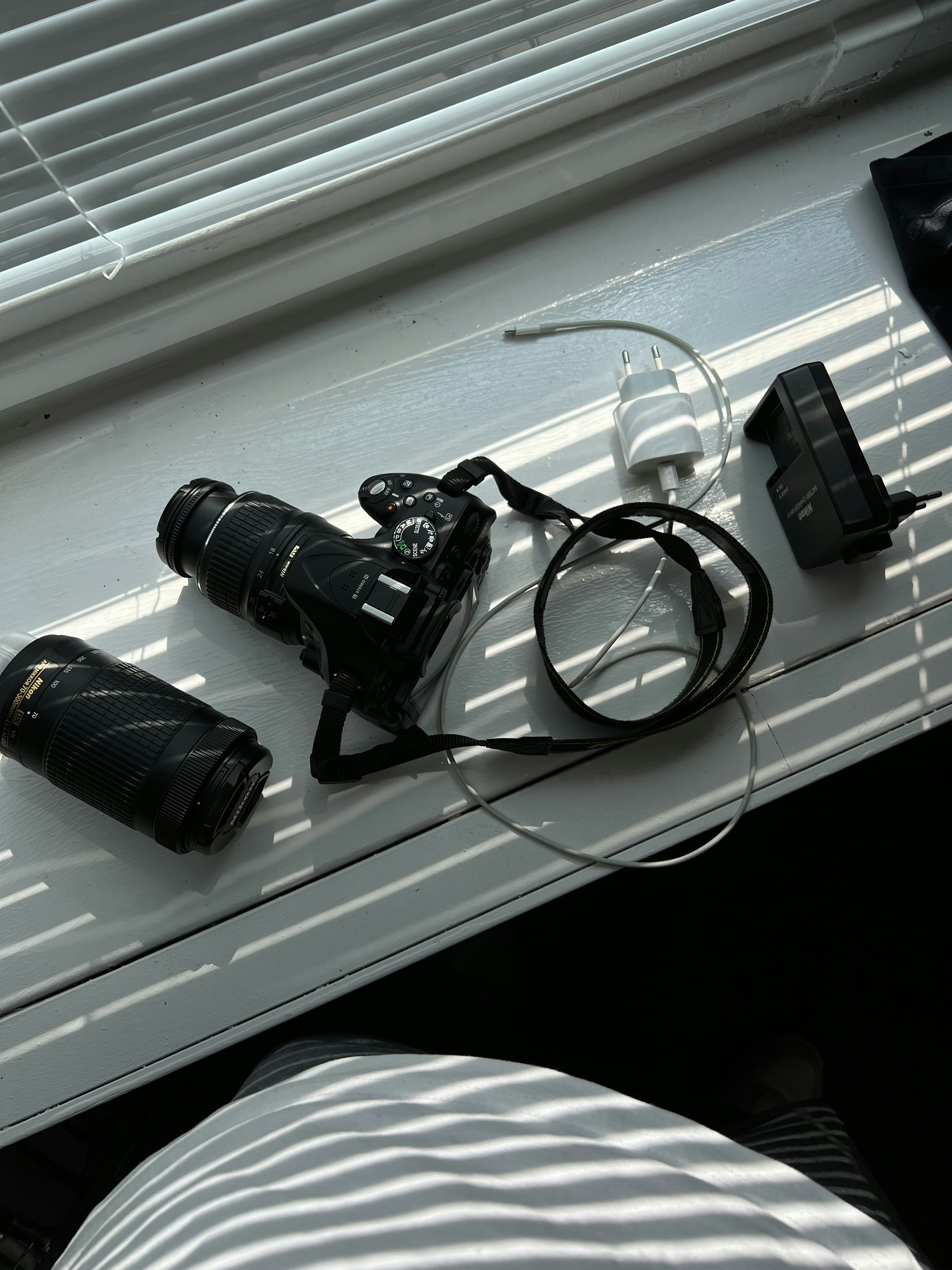A couple of cameras sitting on top of a window sill photo – Free New ...