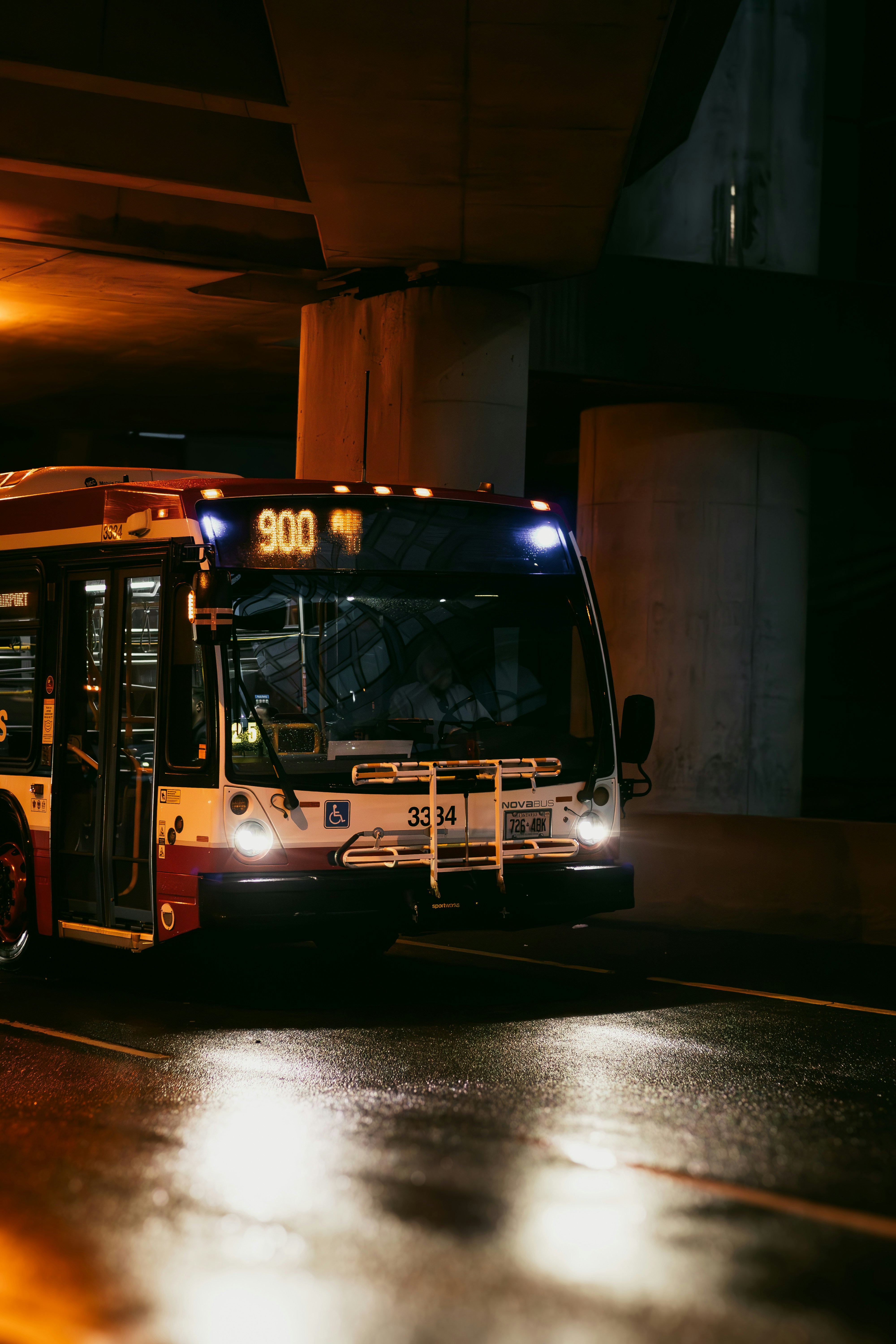 A city bus driving down a street at night photo – Free Toronto Image on ...