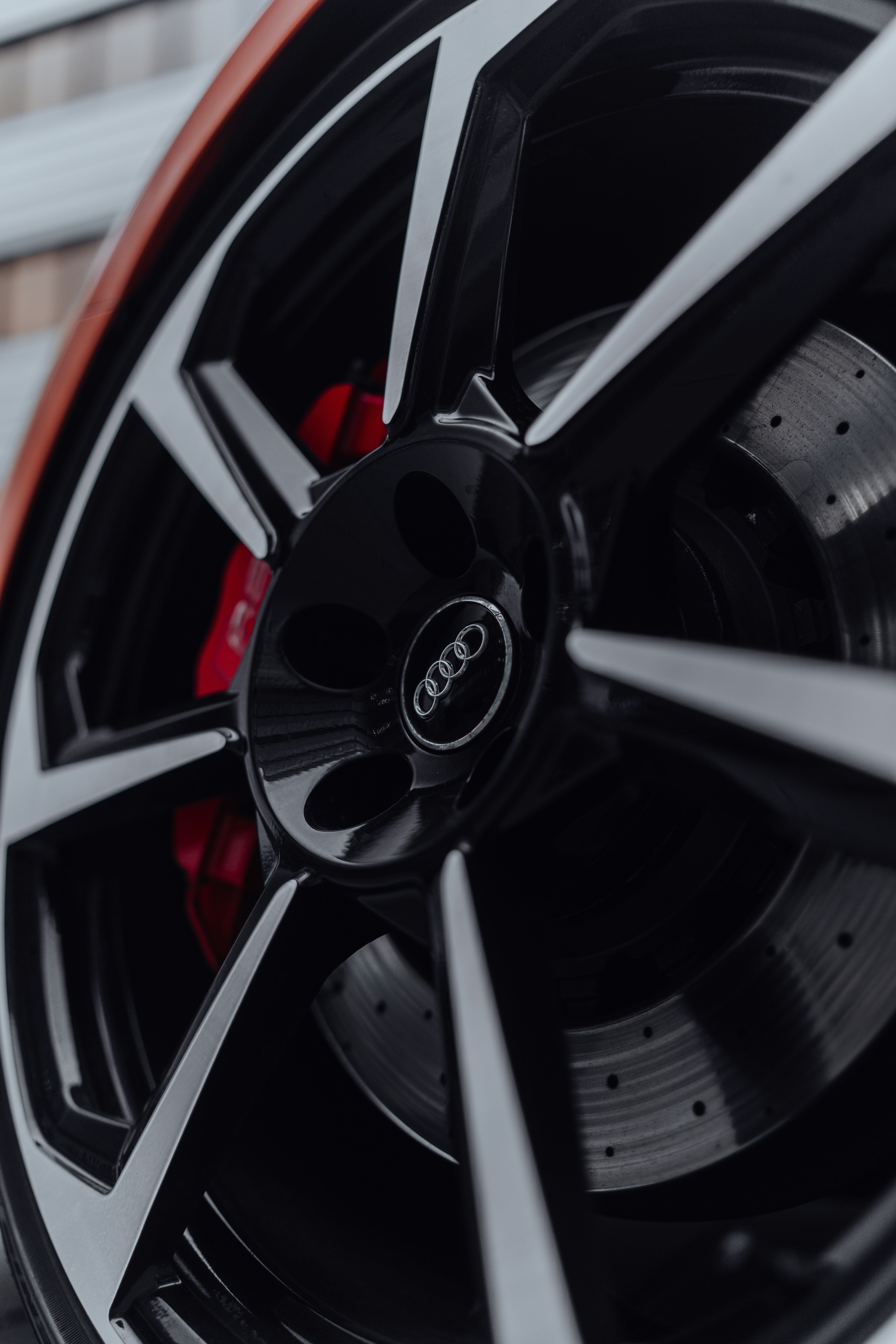 Close-up of a high-performance Audis wheel: forged spokes and red brake caliper