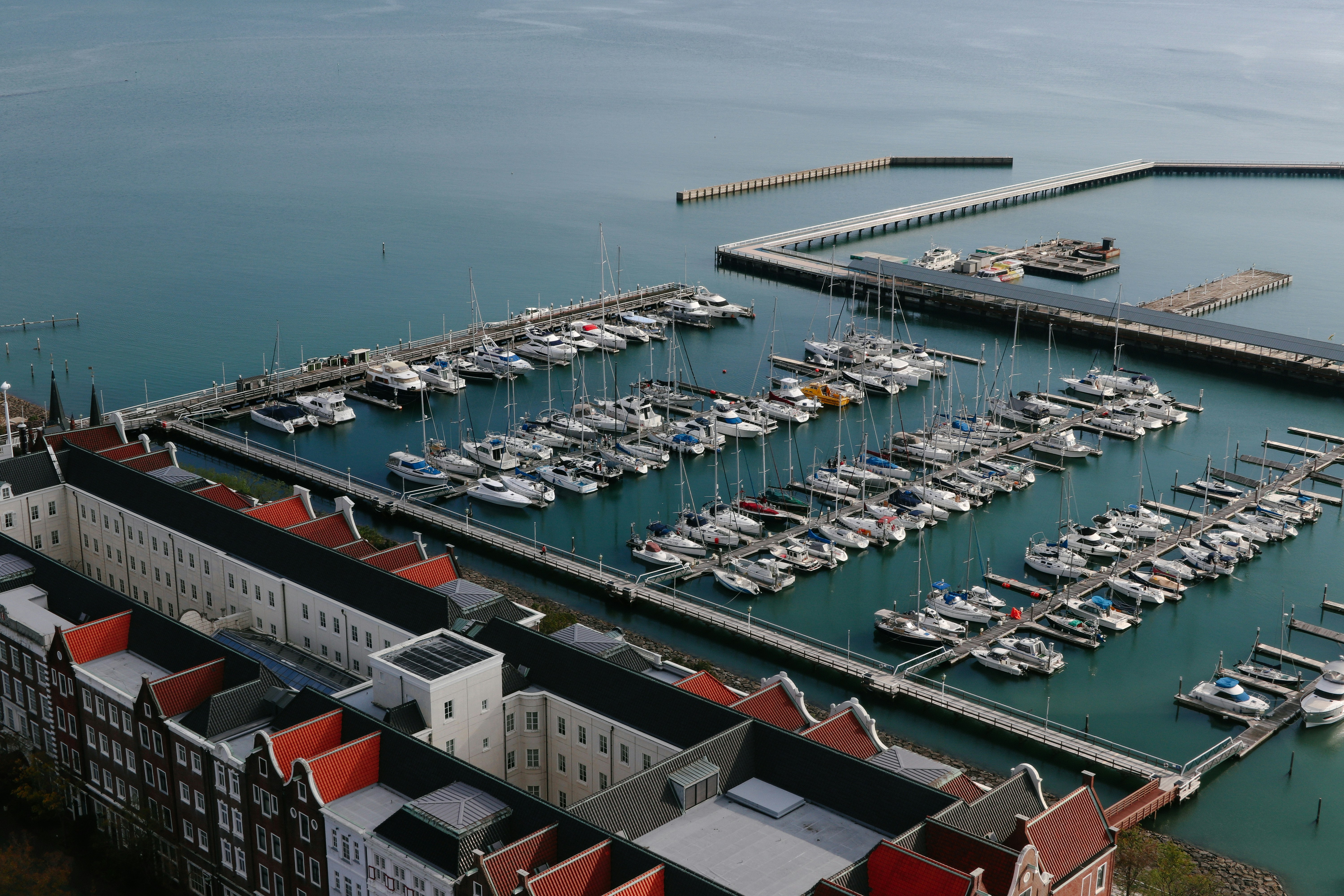 A harbor filled with lots of boats next to buildings photo – Free Grey ...