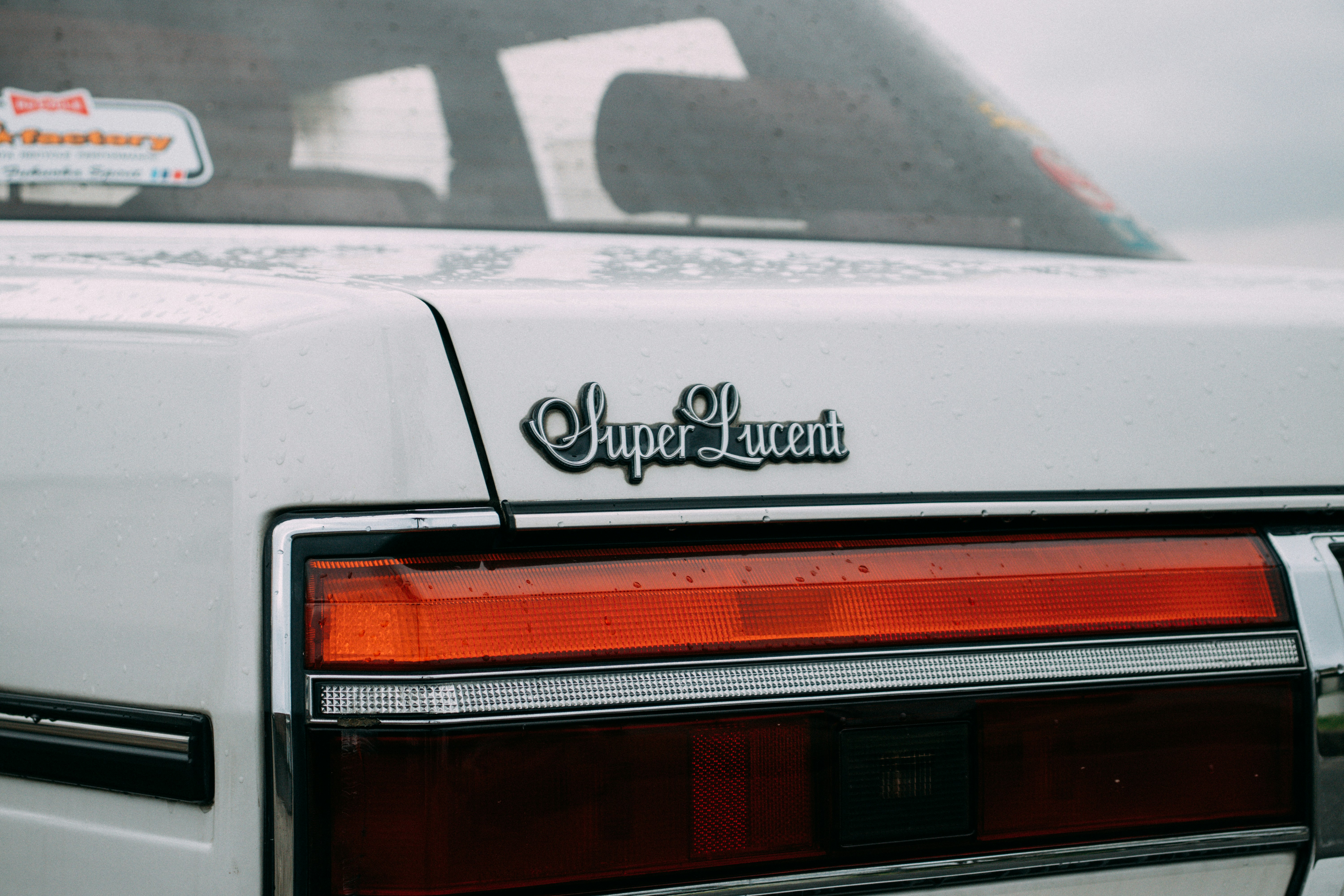 Emblem in Focus: The 'Super Lucent' Badge on a White Trunk