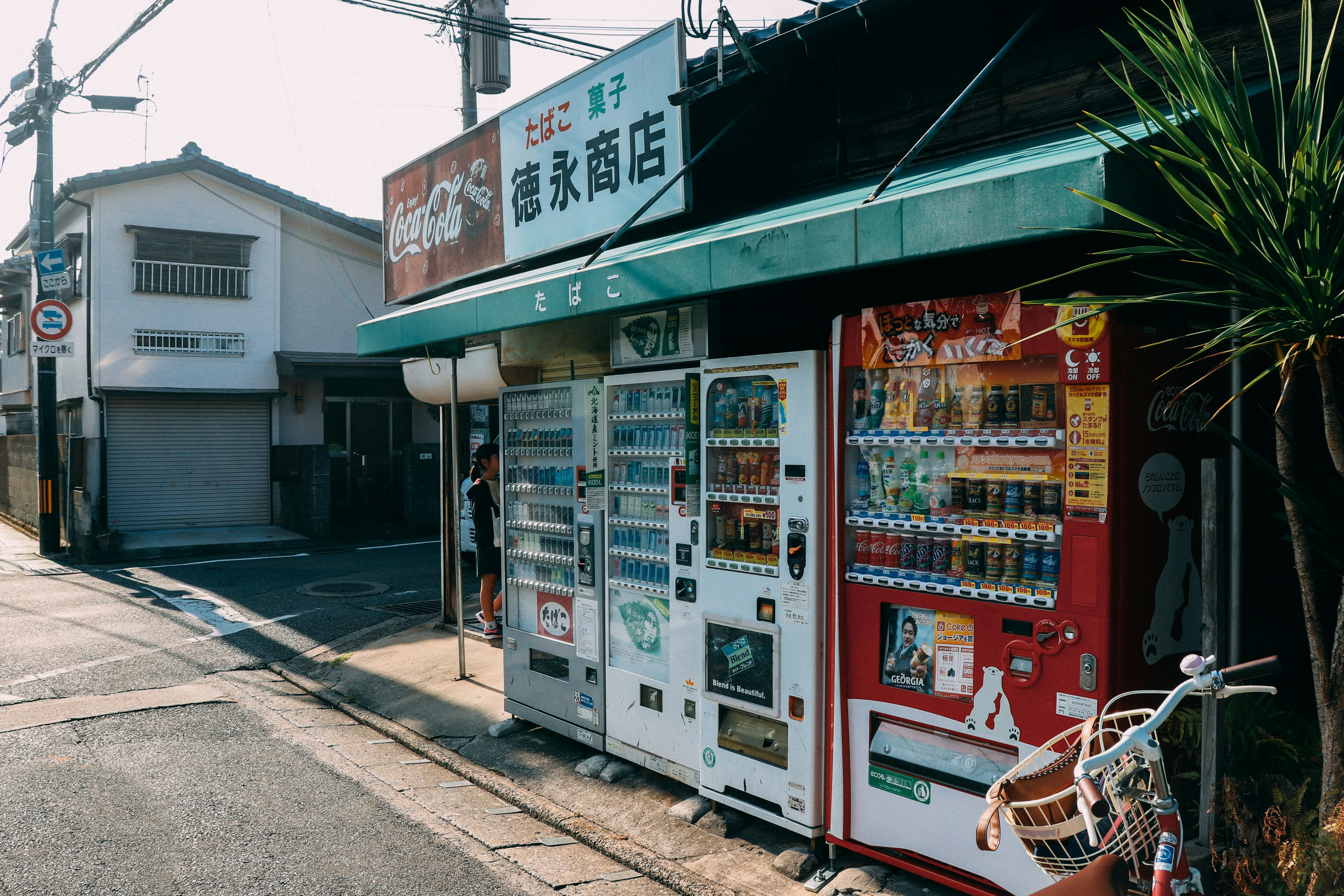 A vending machine sitting on the side of a road photo – Free Machine ...
