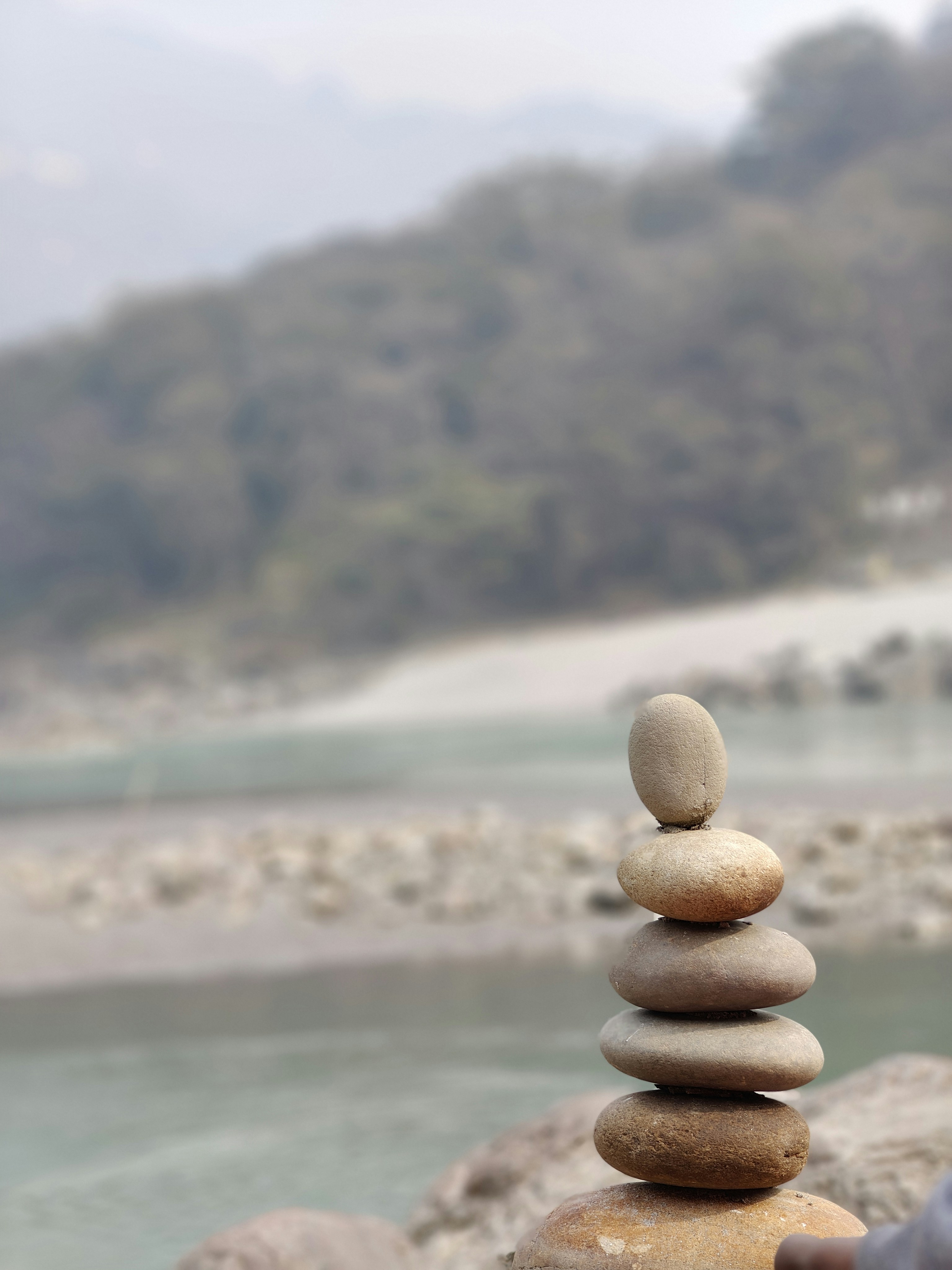 A stack of rocks sitting on top of a beach photo – Free India Image on ...