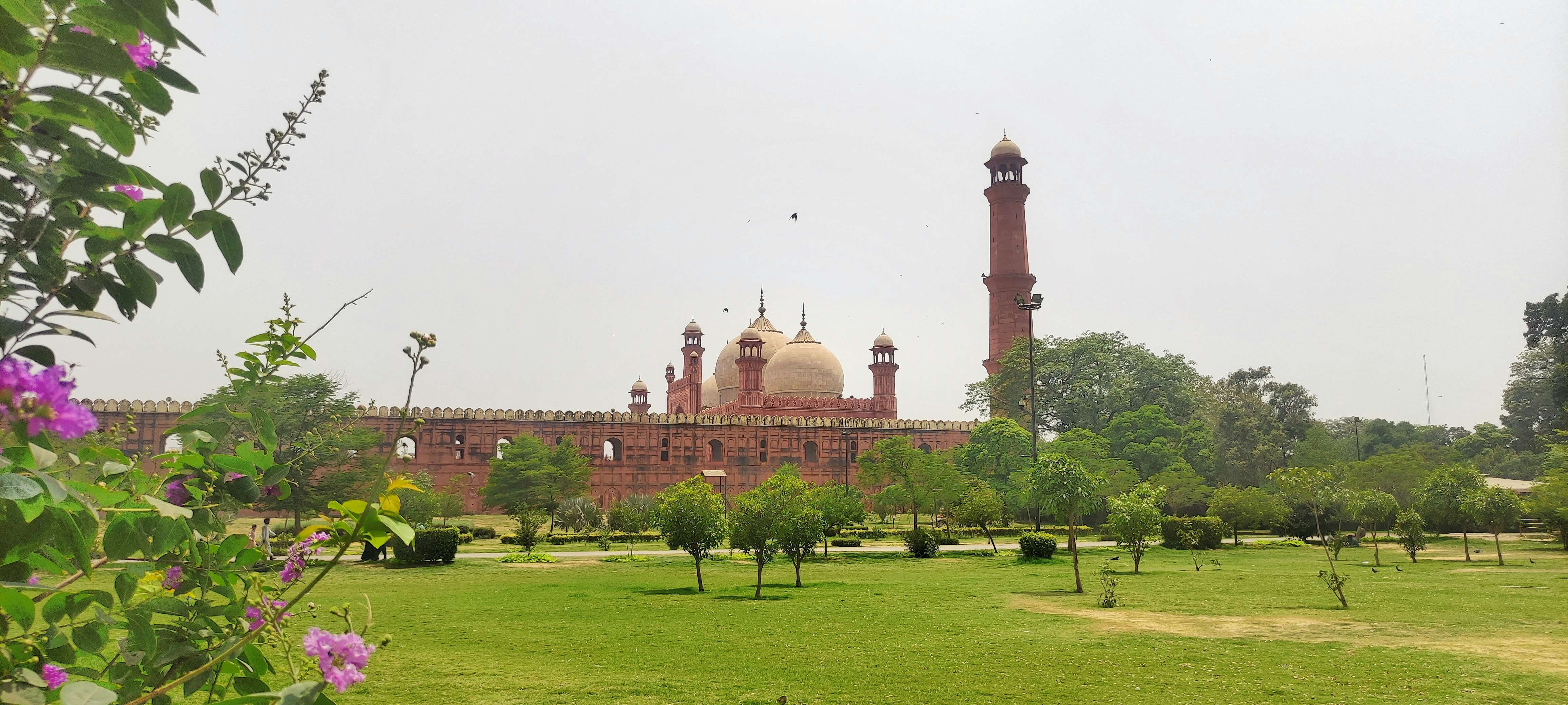 Badshahi Mosque, Lahore, Pakistan | a large building with a tall tower in the background