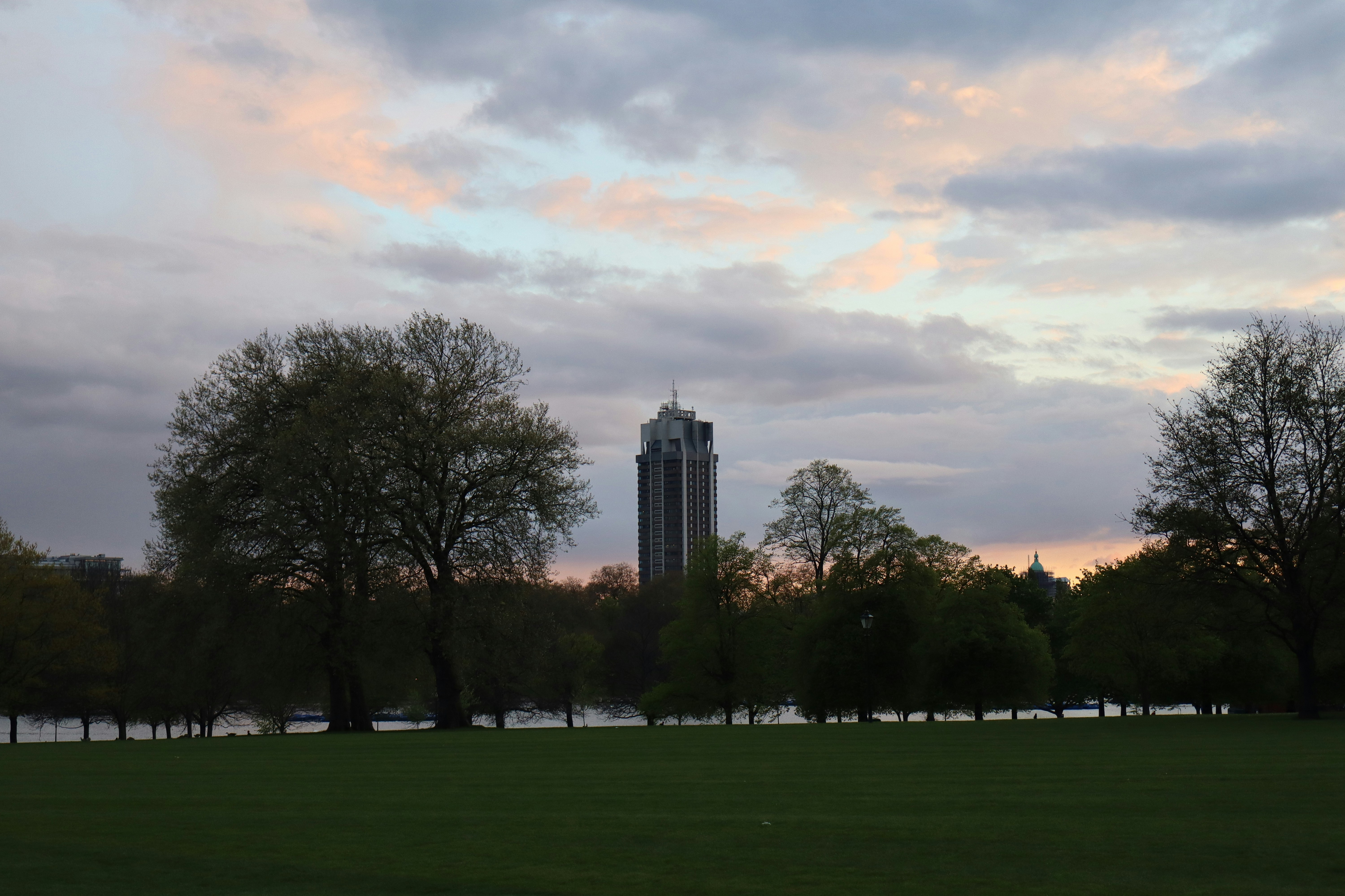 Horizon Needle: A City Tower Emerges Above a Quiet Park at Sunset.