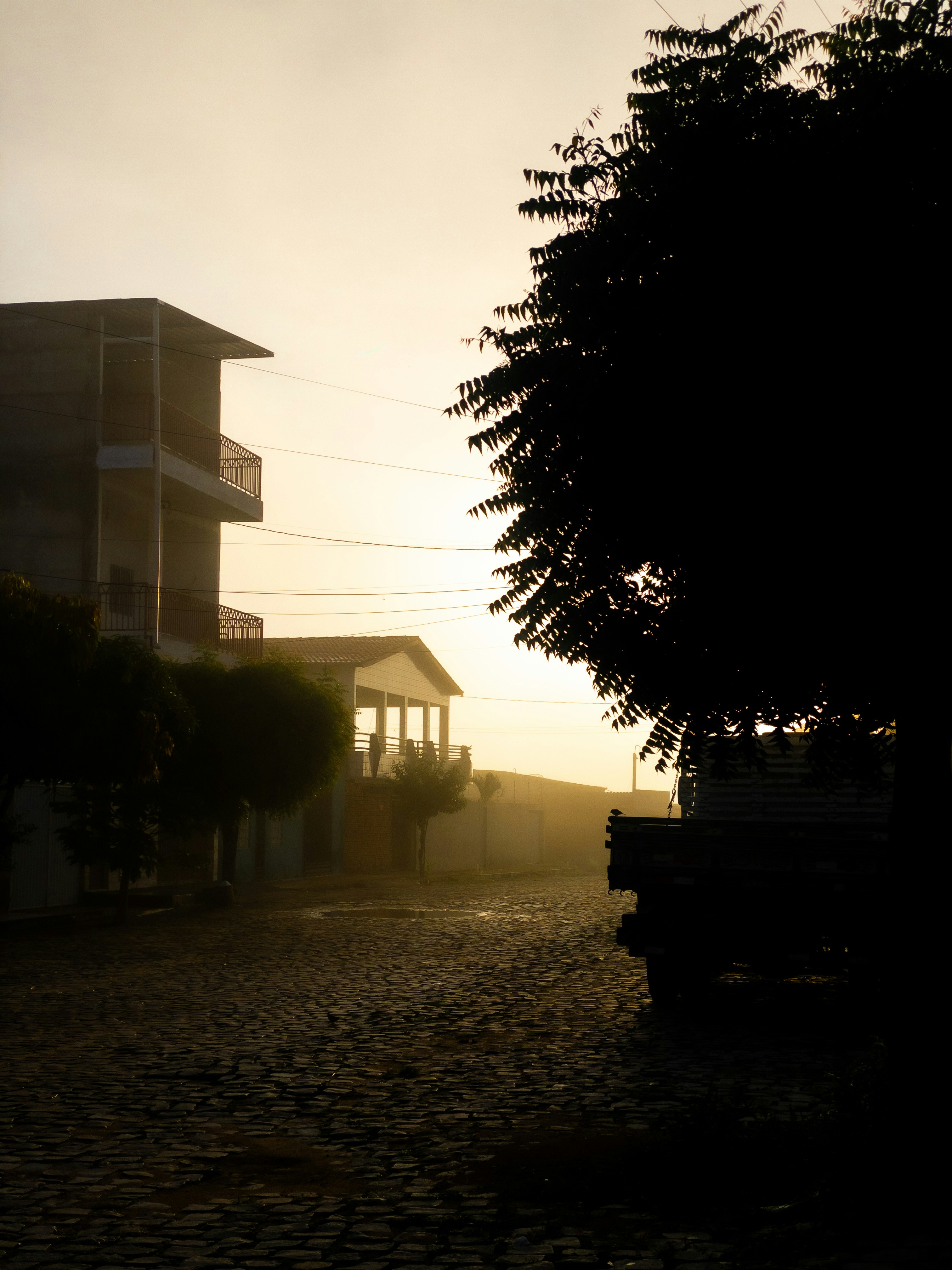 Sunset Silhouette on a Cobblestone Street