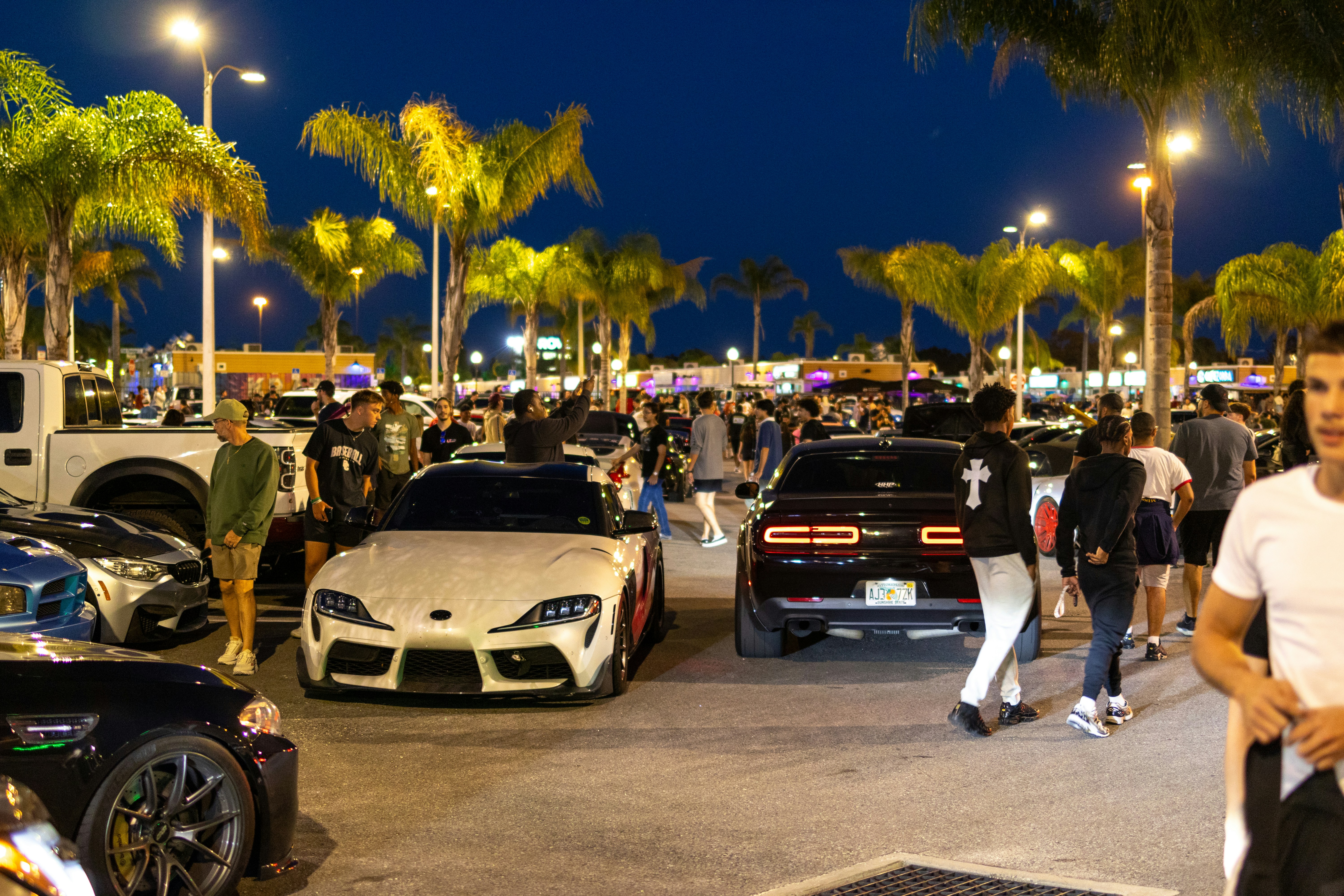A crowd of people walking around a parking lot photo – Free Wallpaper ...