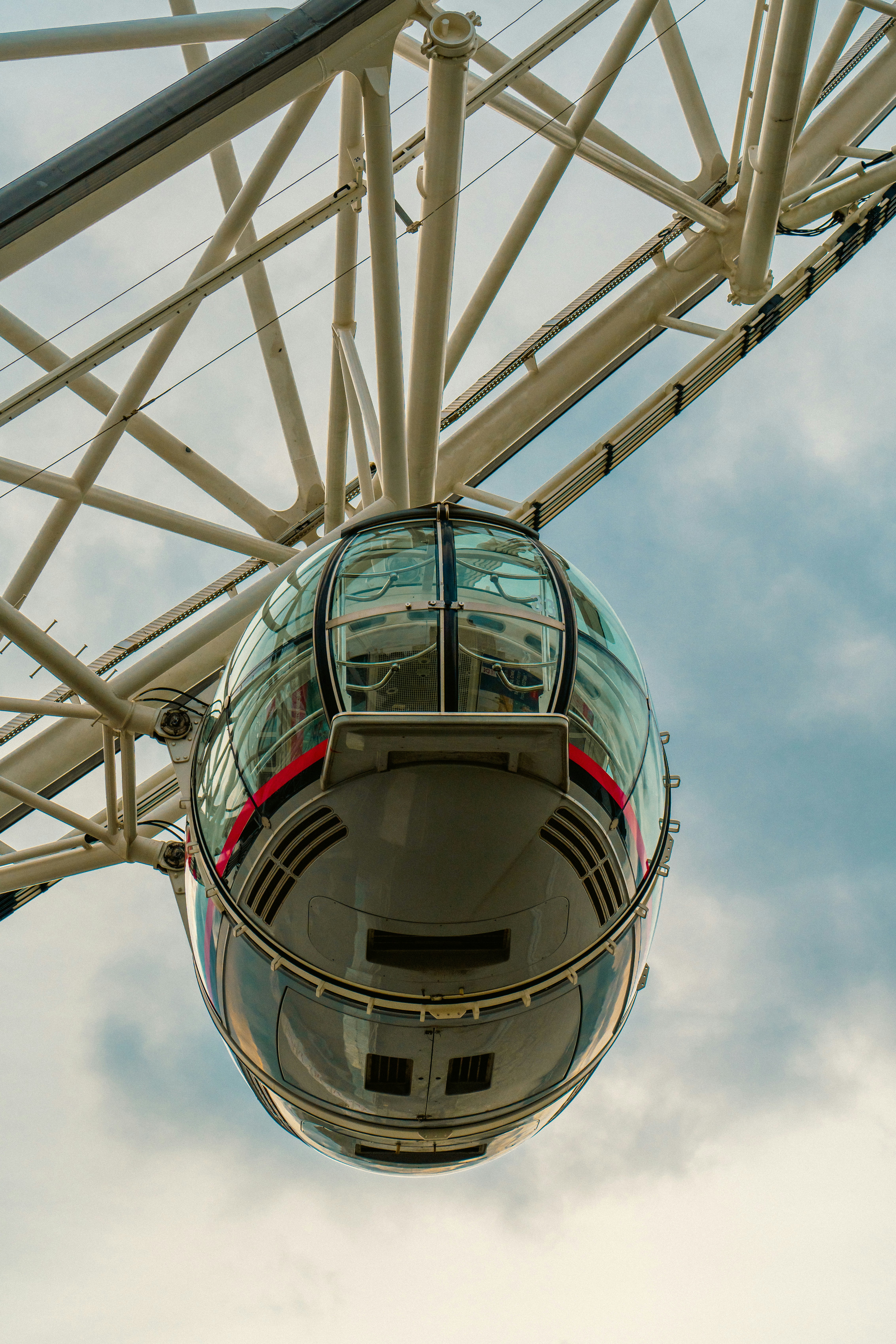 Sphere Amid Steel: Glass Capsule Anchored to the White Lattice