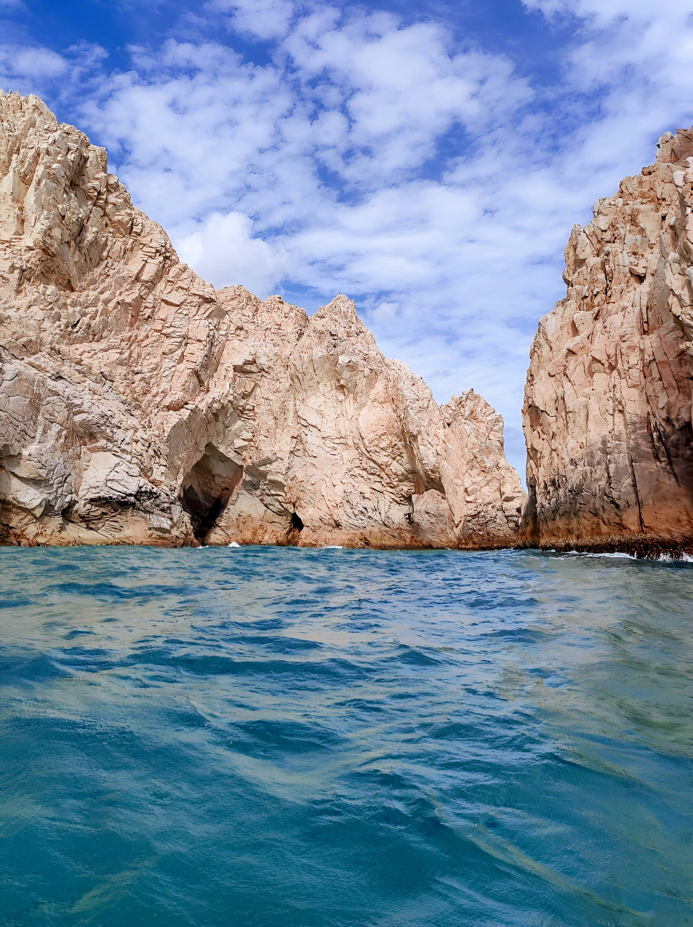 A body of water with rocks in the background photo – Free Los cabos ...