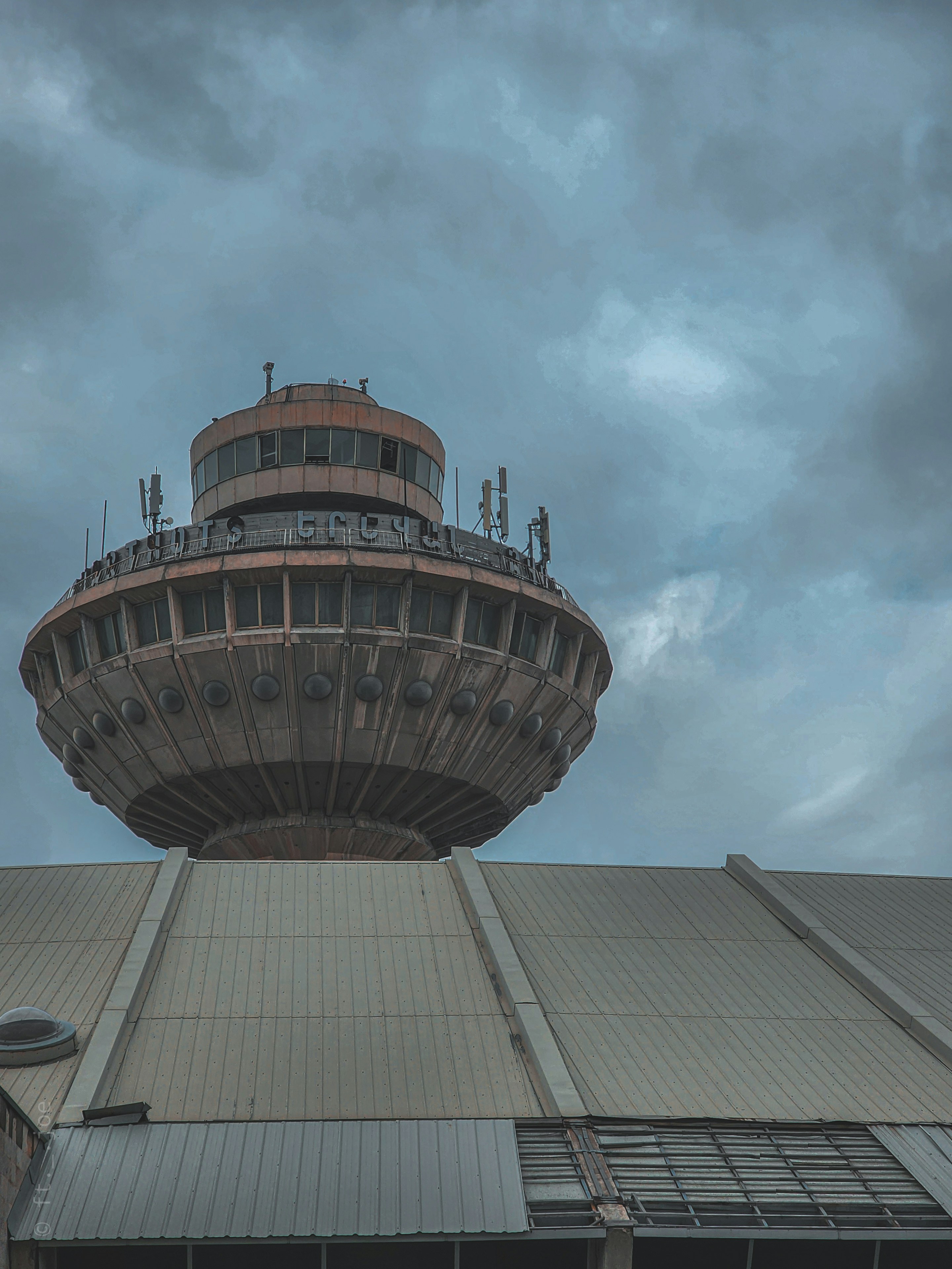 Air Traffic Control Tower of EVN airport | a large building with a very tall tower on top of it