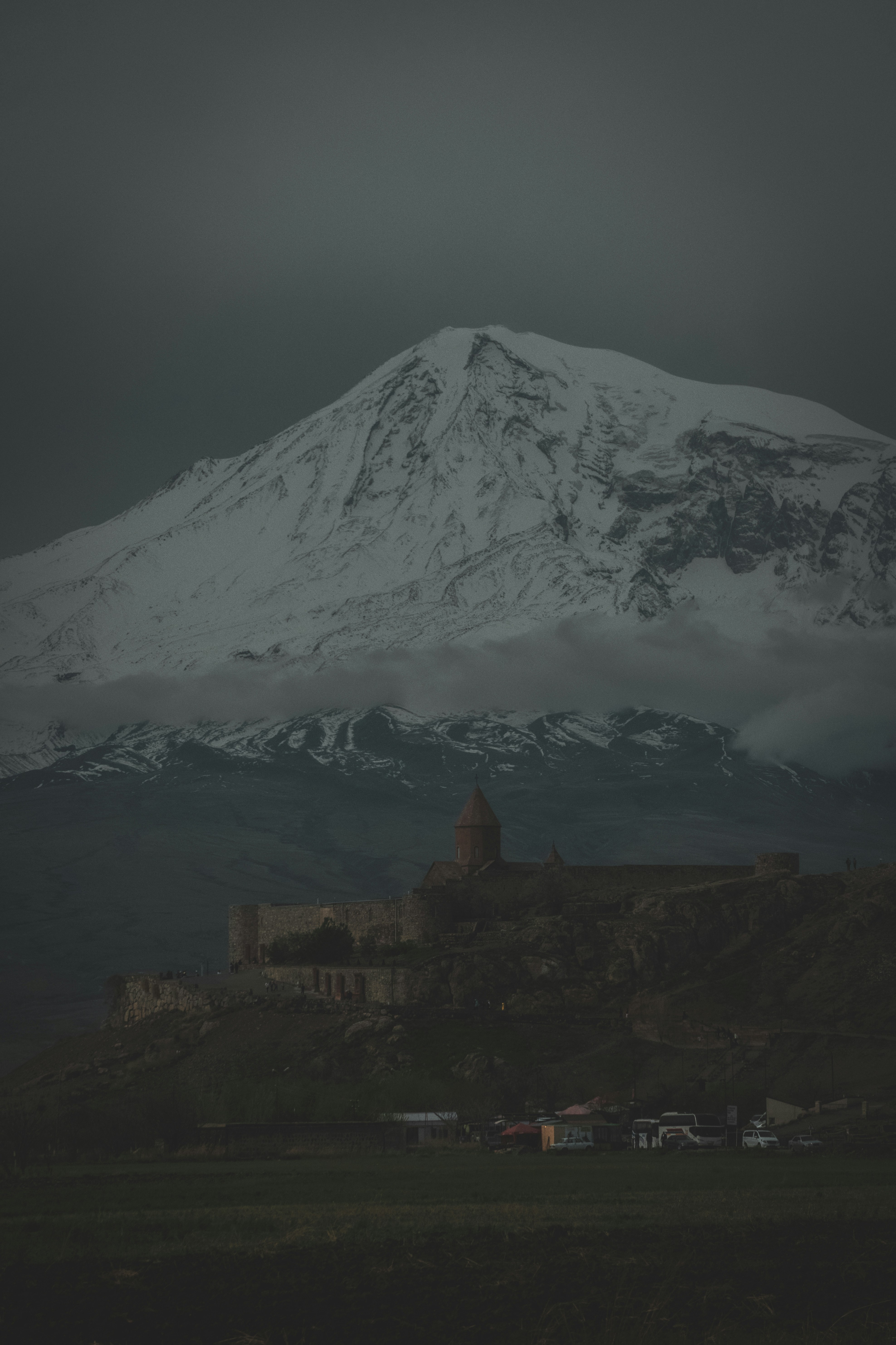 Red-roofed Fortress Beneath a Snow-Crowned Summit