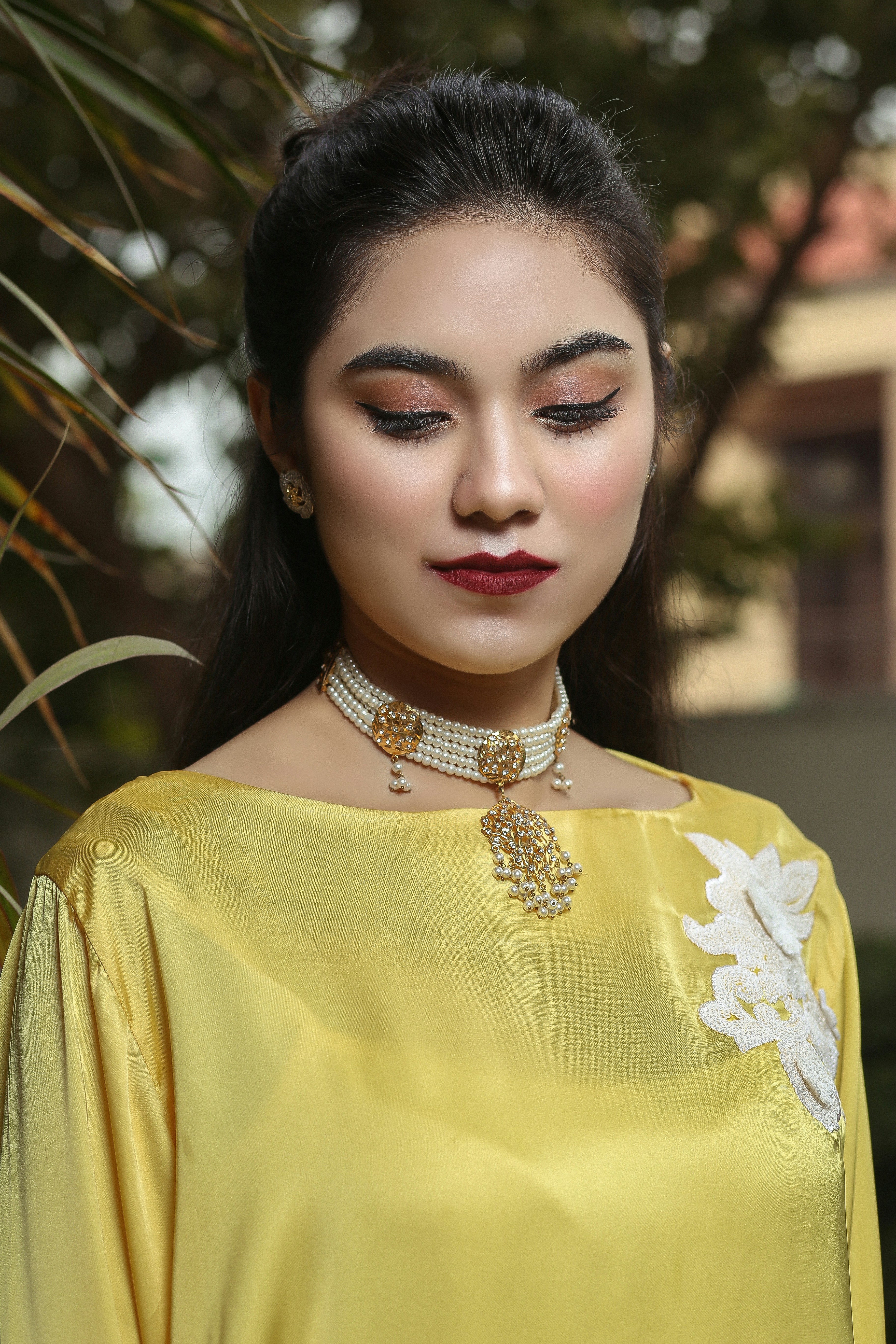 A woman wearing a yellow dress and a necklace photo – Free Naeem ad studios Image on Unsplash