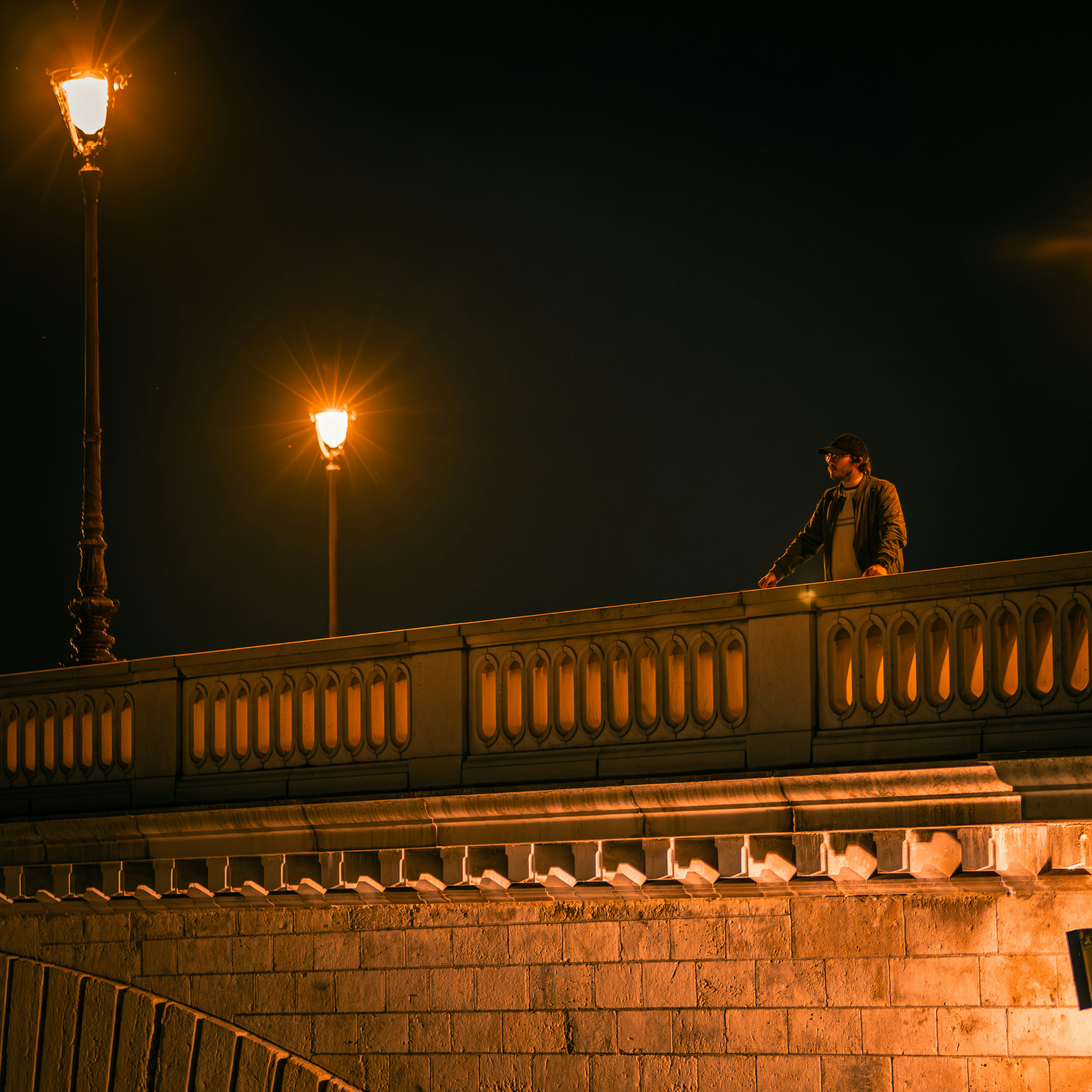 Amber Lanterns Embrace a Night-Walker on the Bridge