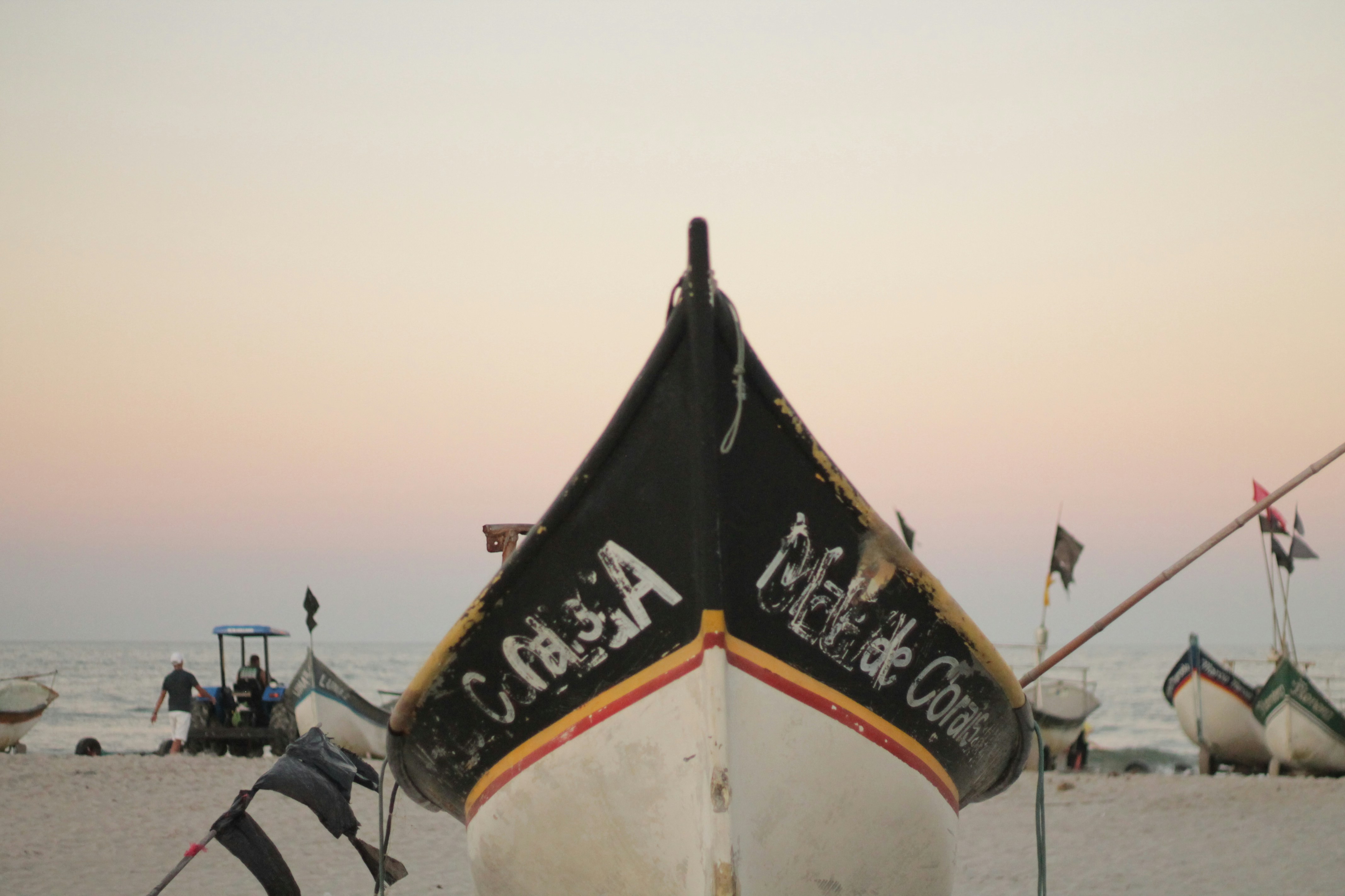 Bow of a Painted Vessel Quietly Graces a Sunset Beach