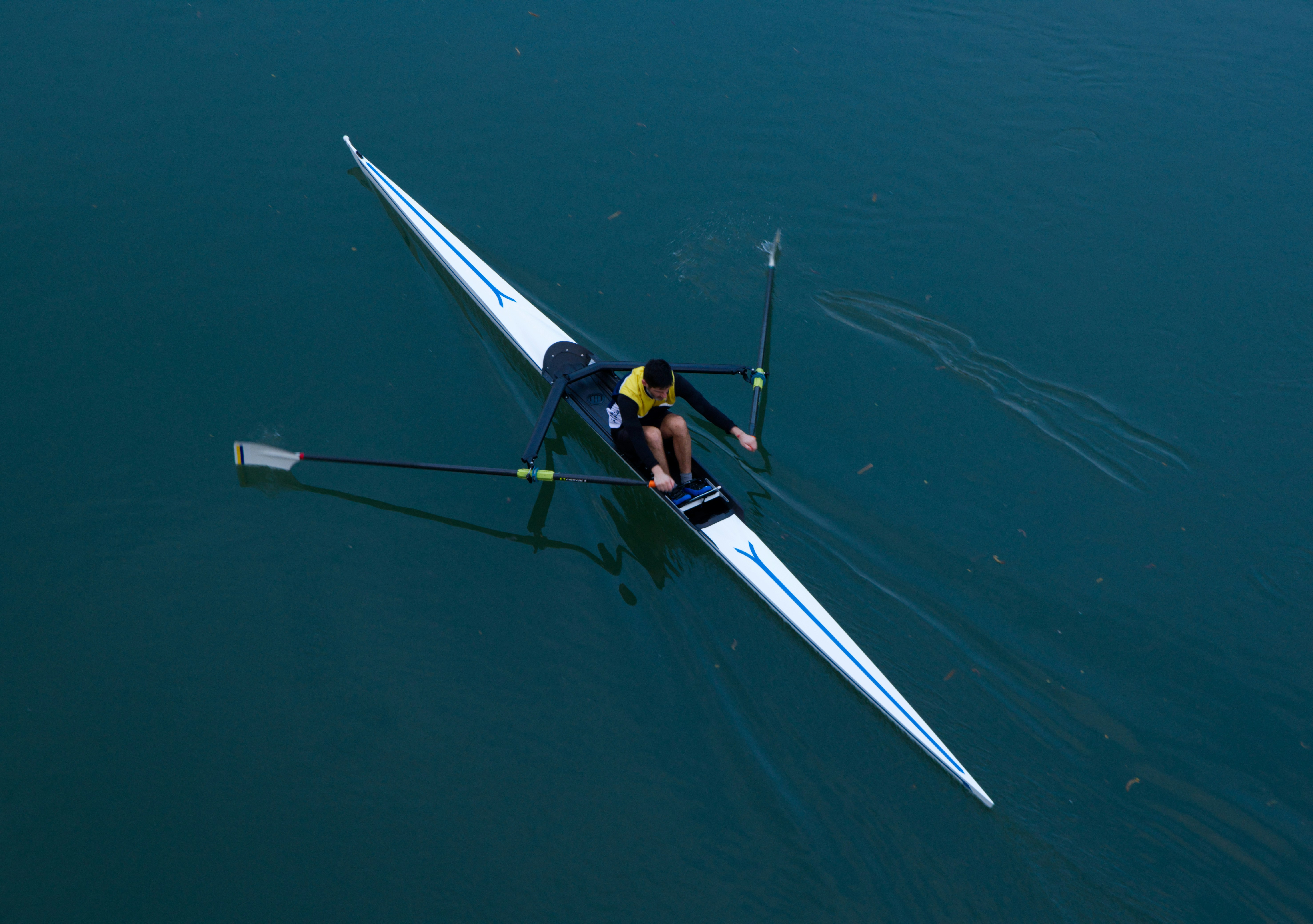 A person rowing a boat on a body of water photo – Free Water sports ...