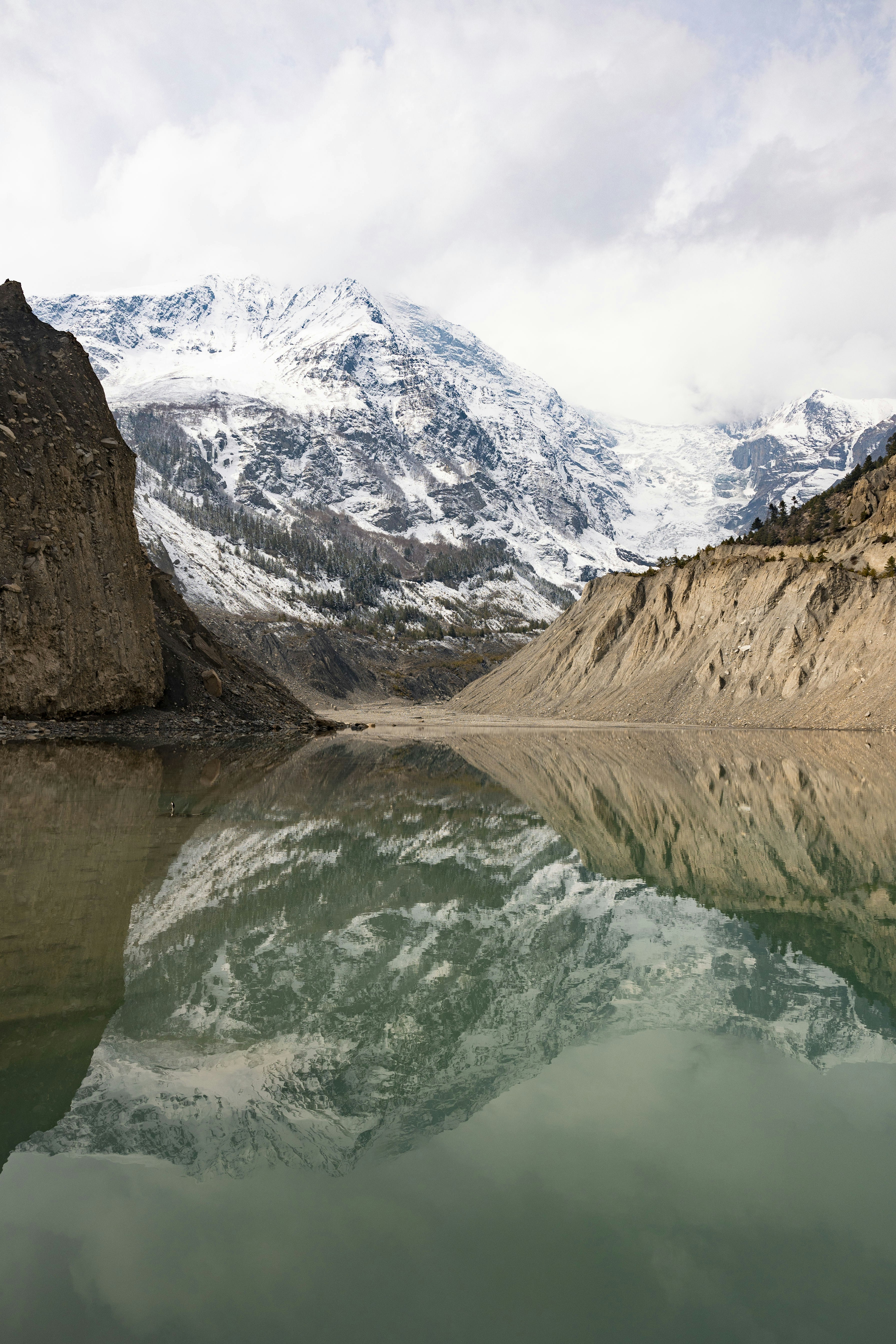 Echoes of the Summit: Snow-Crowned Peaks Reflected in a Glassy Alpine Lake