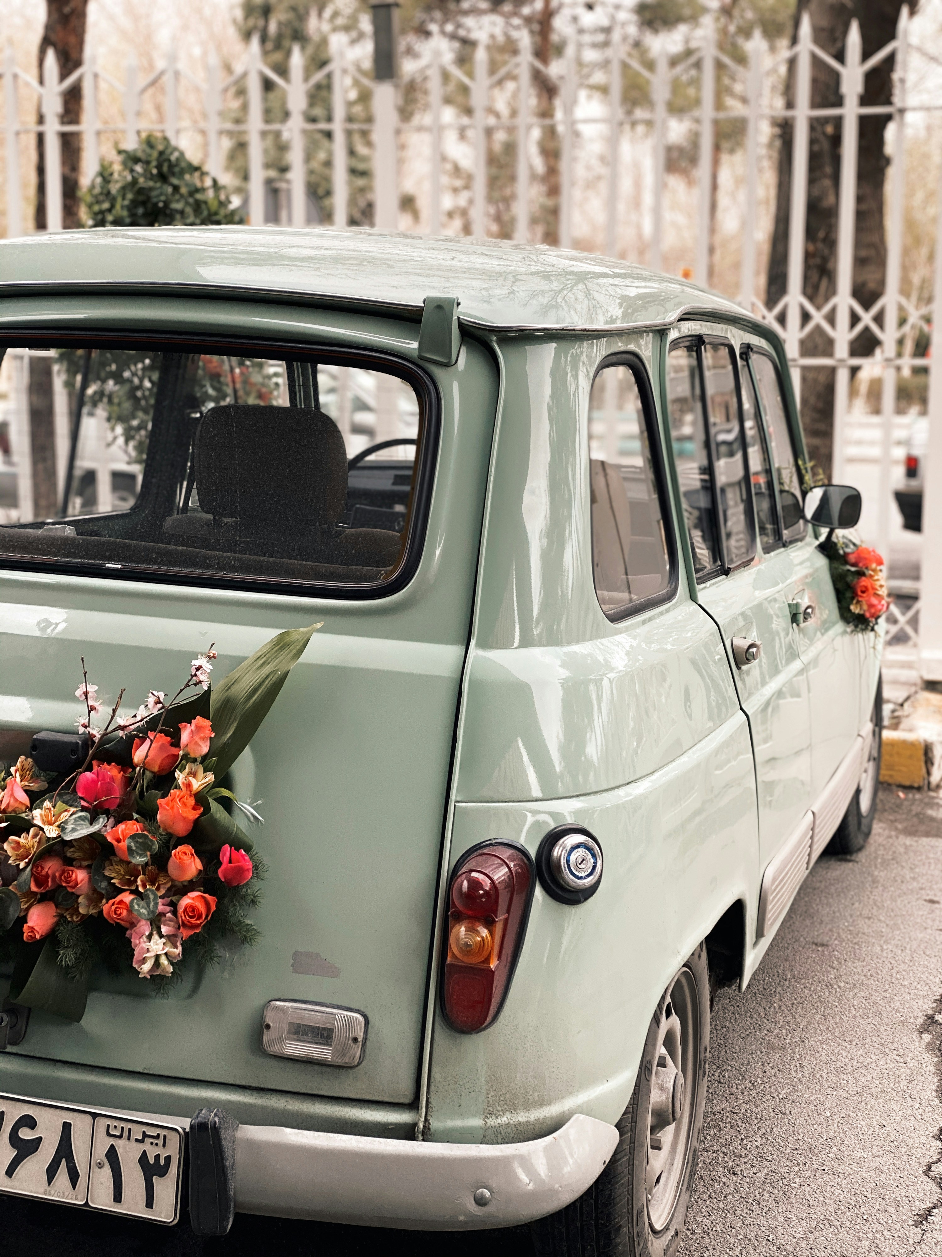 Floral Accent on a Mint Vintage Car in a Quiet Parking Lot