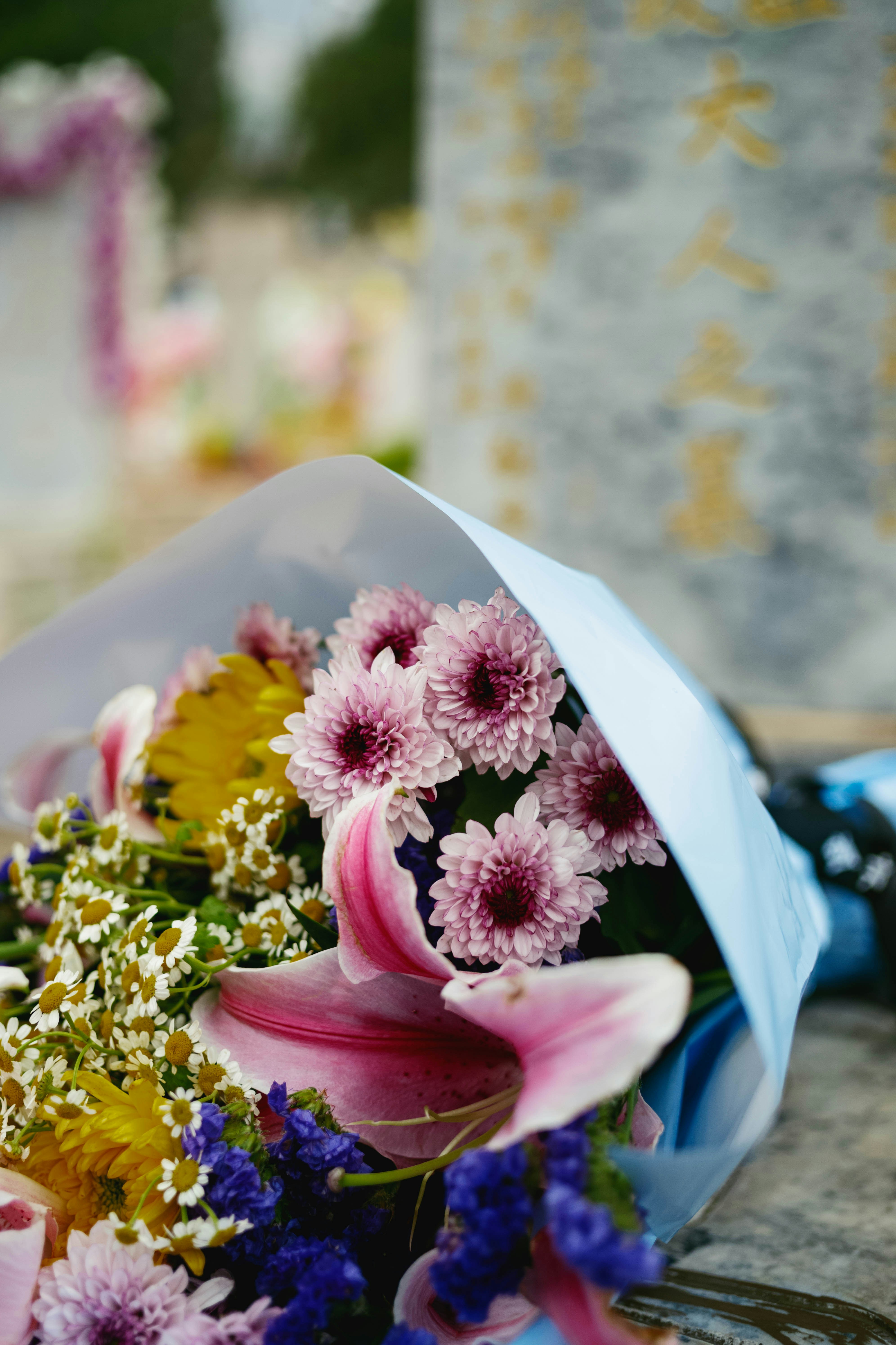 Bouquet of Memory: Fresh Flowers Resting on a Grave Marker
