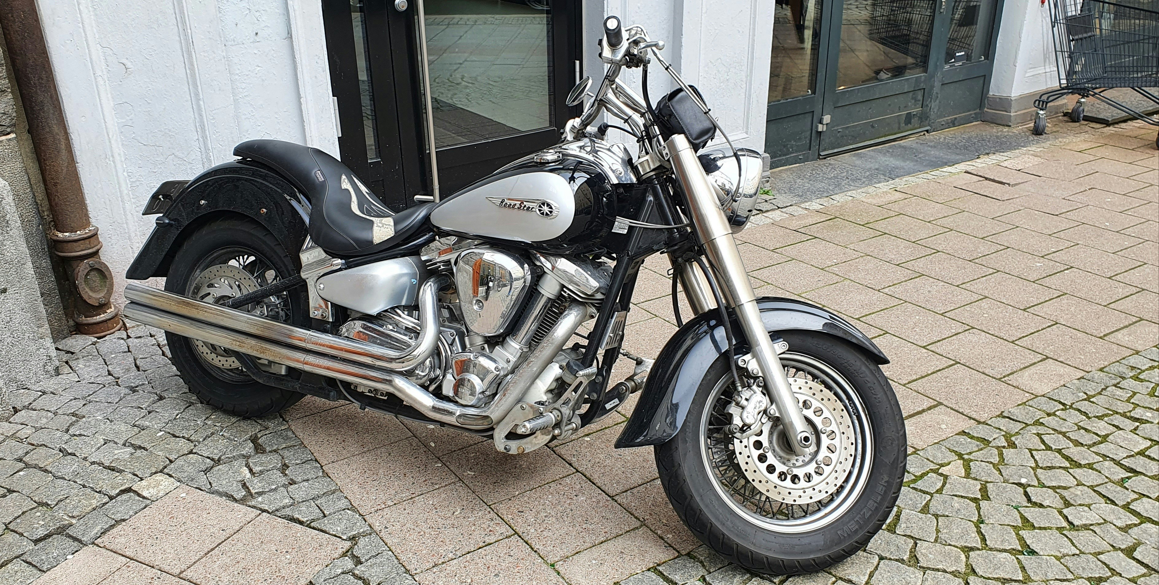 Iron Horse on Cobblestones: Chrome Meets Glass by a Quiet Street