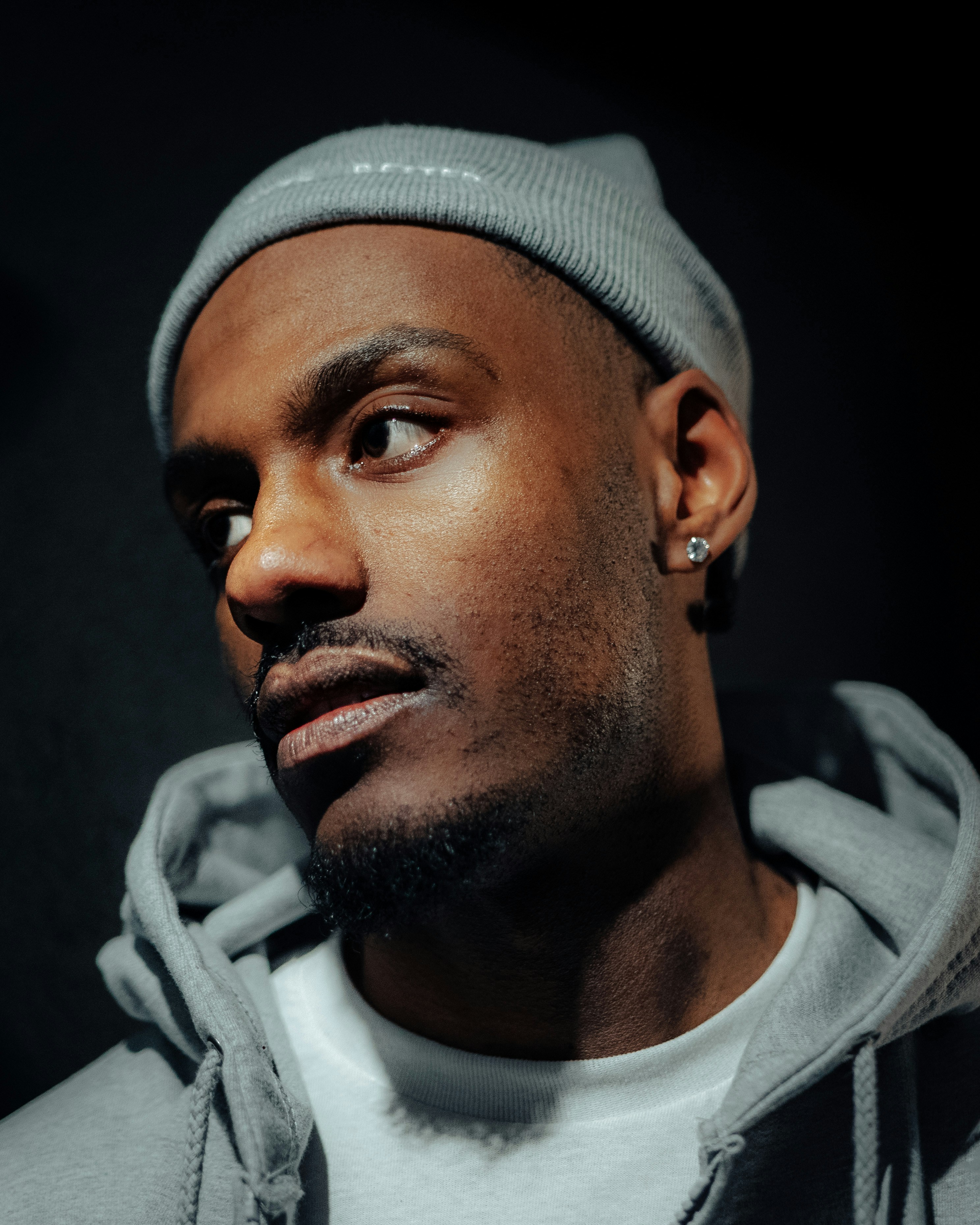 Quiet Intensity: A Gaze Shaped by Light and Hoodie