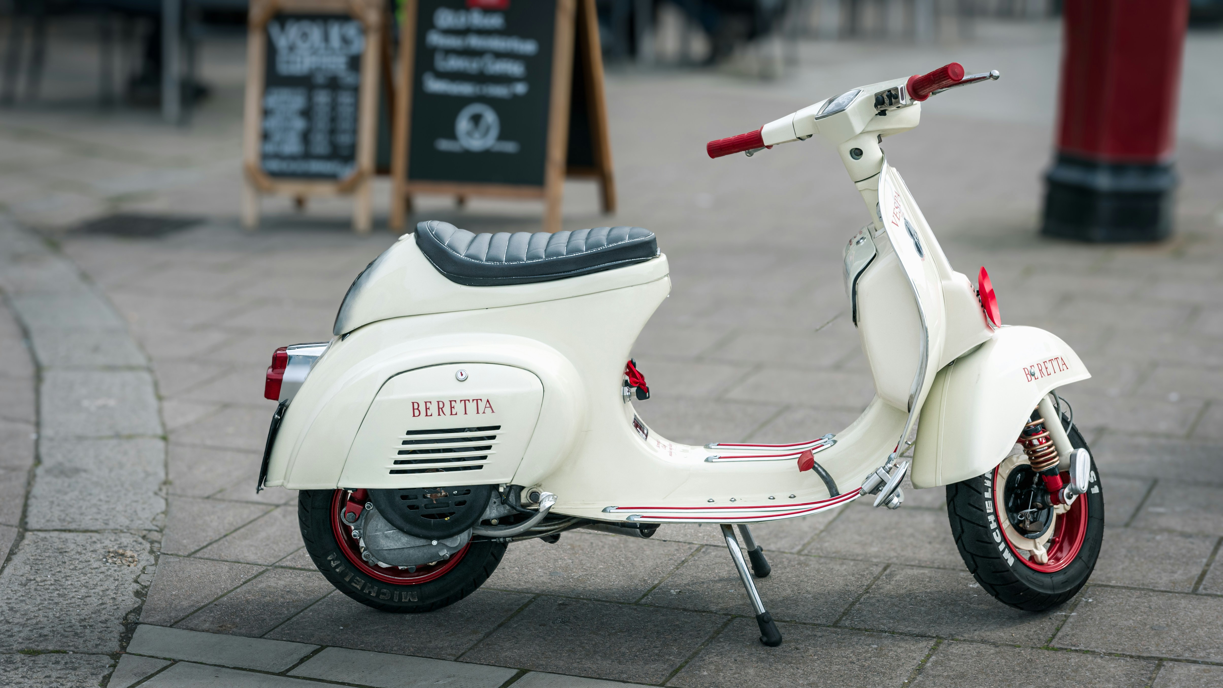 Cream Vespa Standby: A Retro Scooter Quietly Anchors a Pedestrian Square