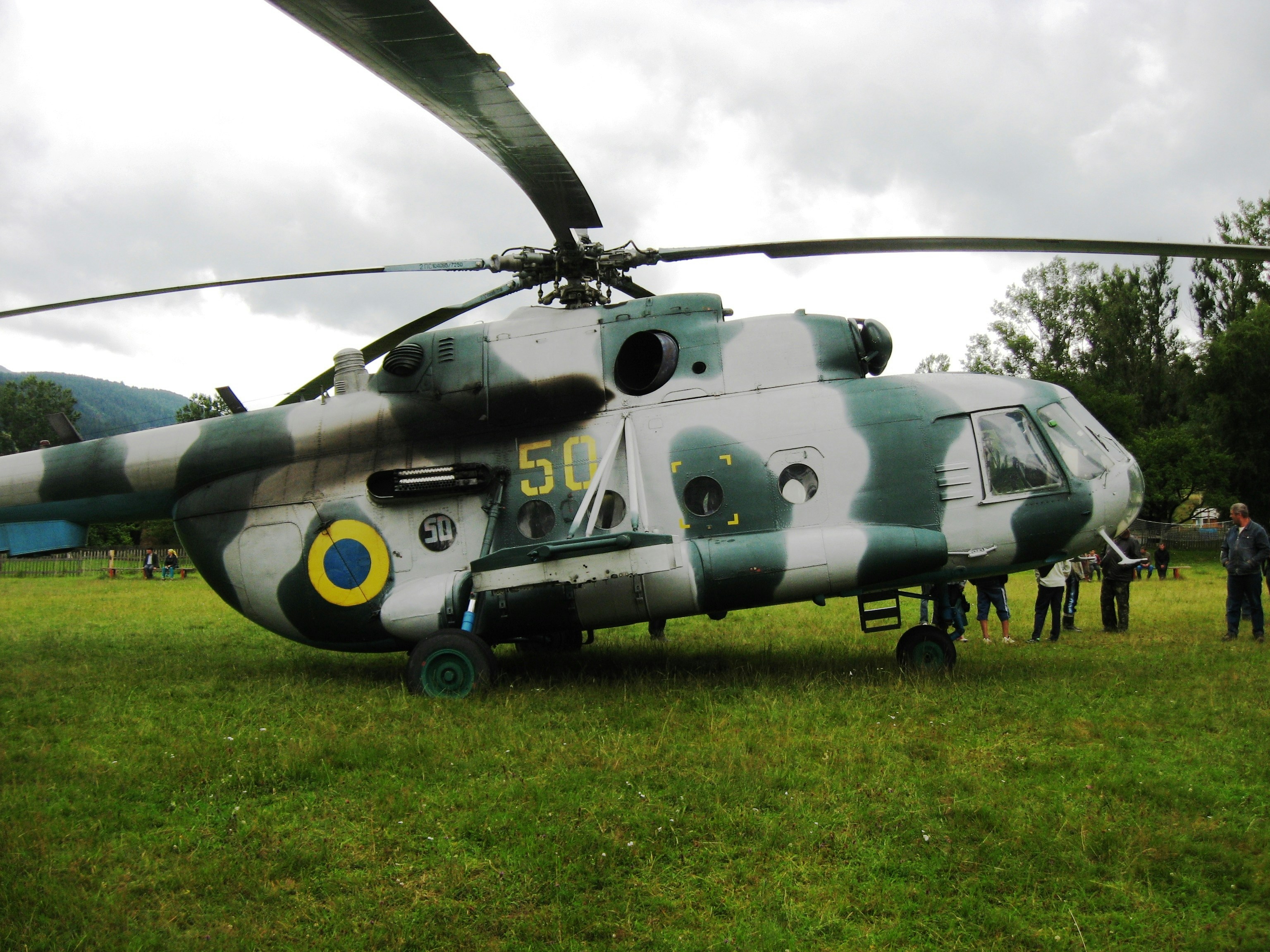 A helicopter that is sitting in the grass photo – Free Child playing ...