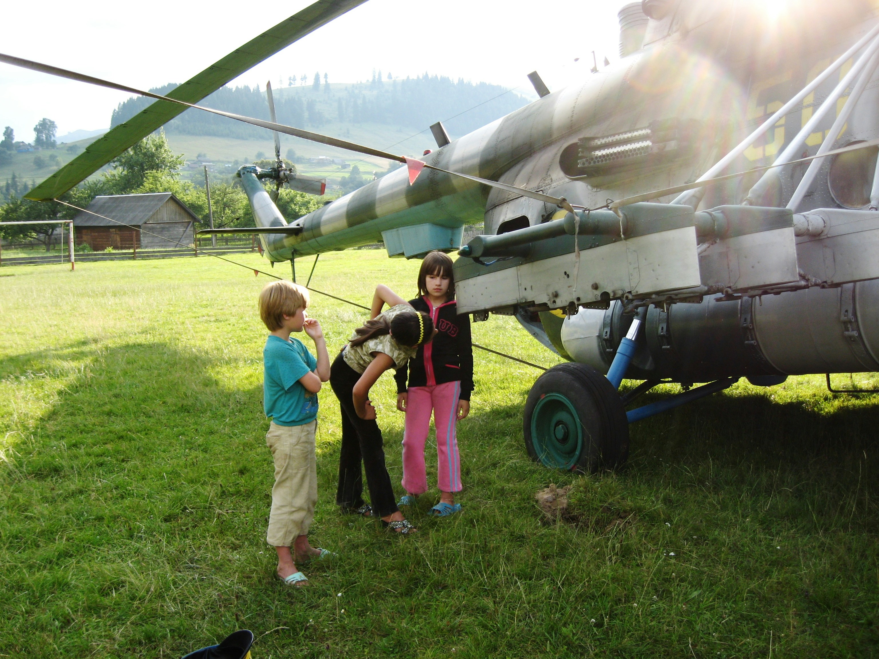 A couple of kids standing in front of a plane photo – Free Child model ...