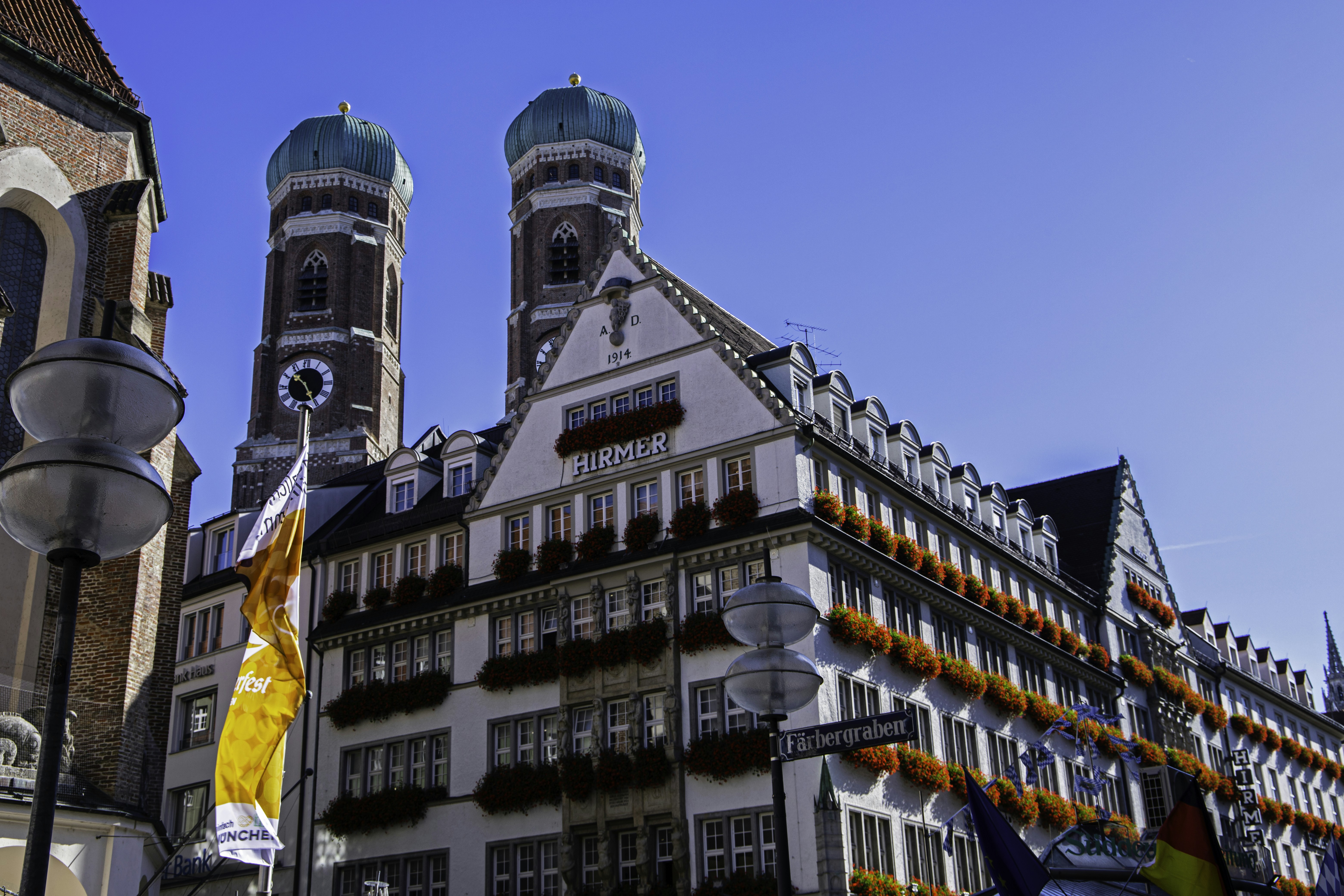 a tall building with a clock tower next to other buildings