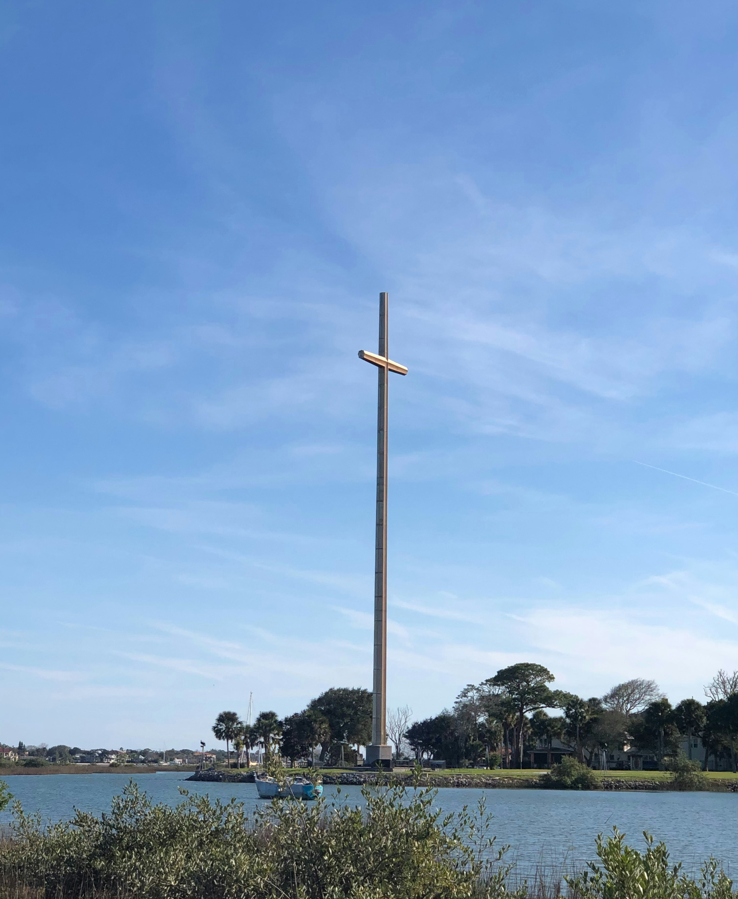 Harbor Sentinel: A lone cross-tower rising above the tranquil inlet