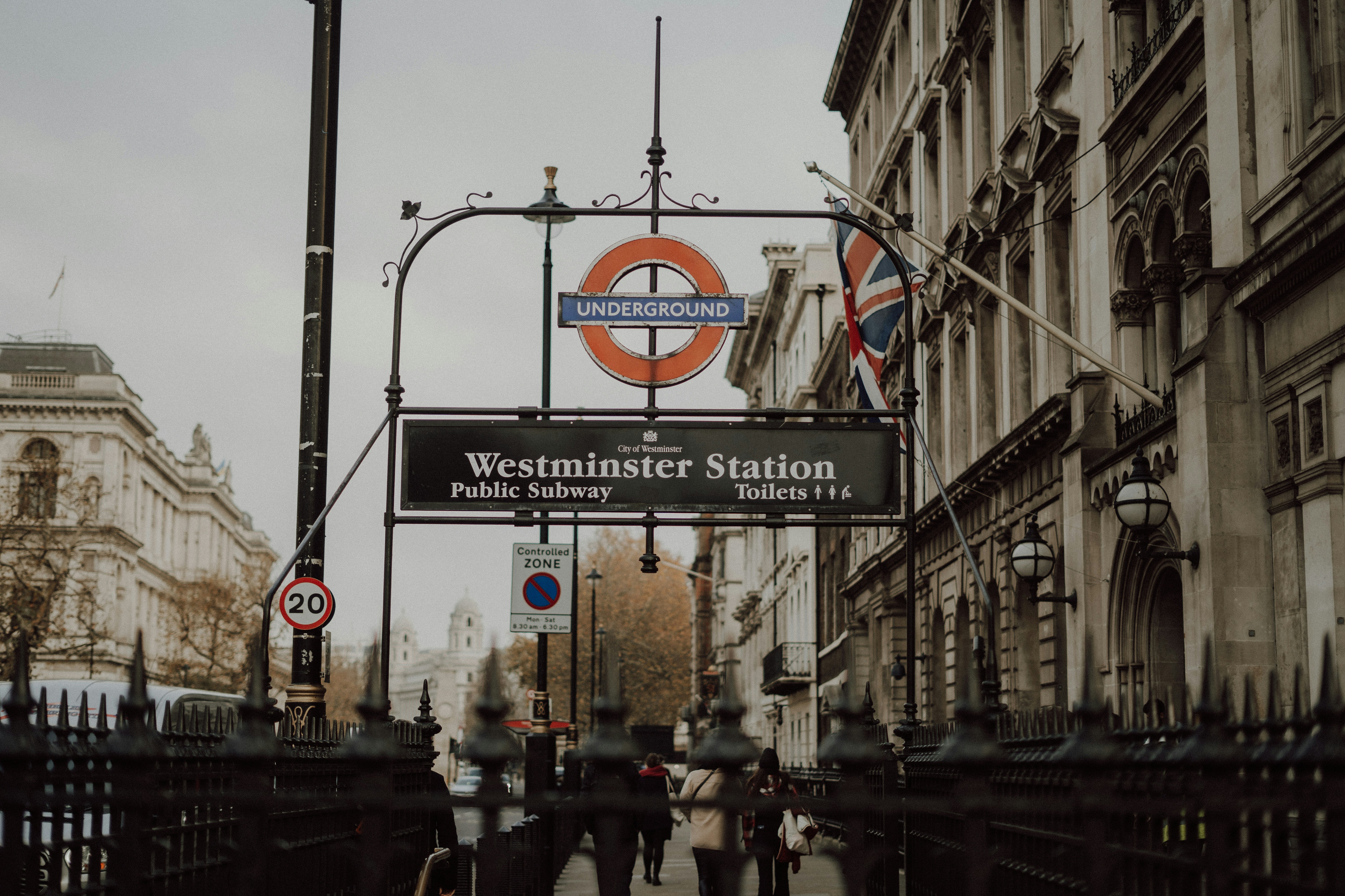 A sign for westminster station on a city street photo – Free City Image ...