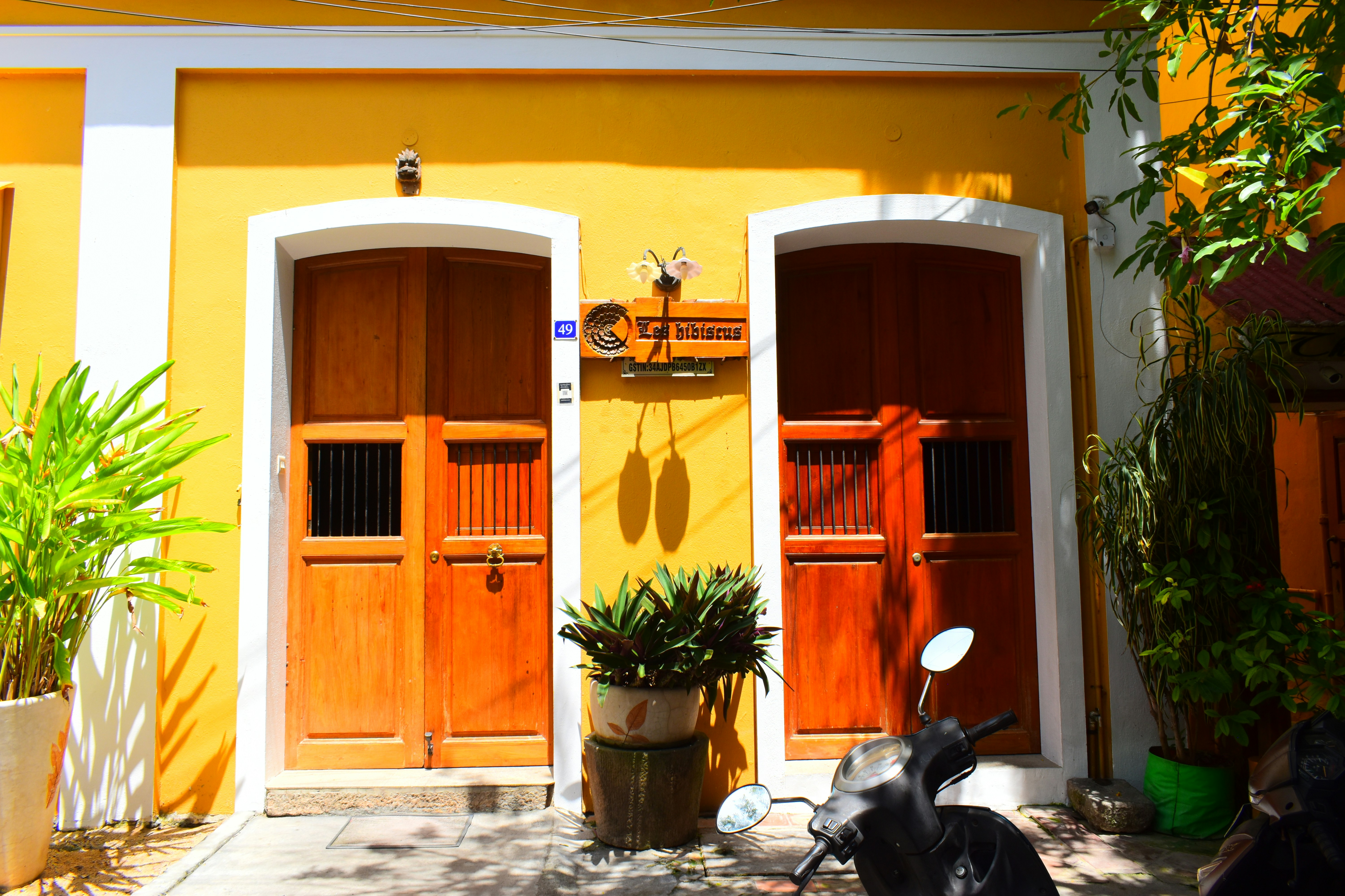 French colony in Pondicherry | a motorcycle parked in front of a yellow building