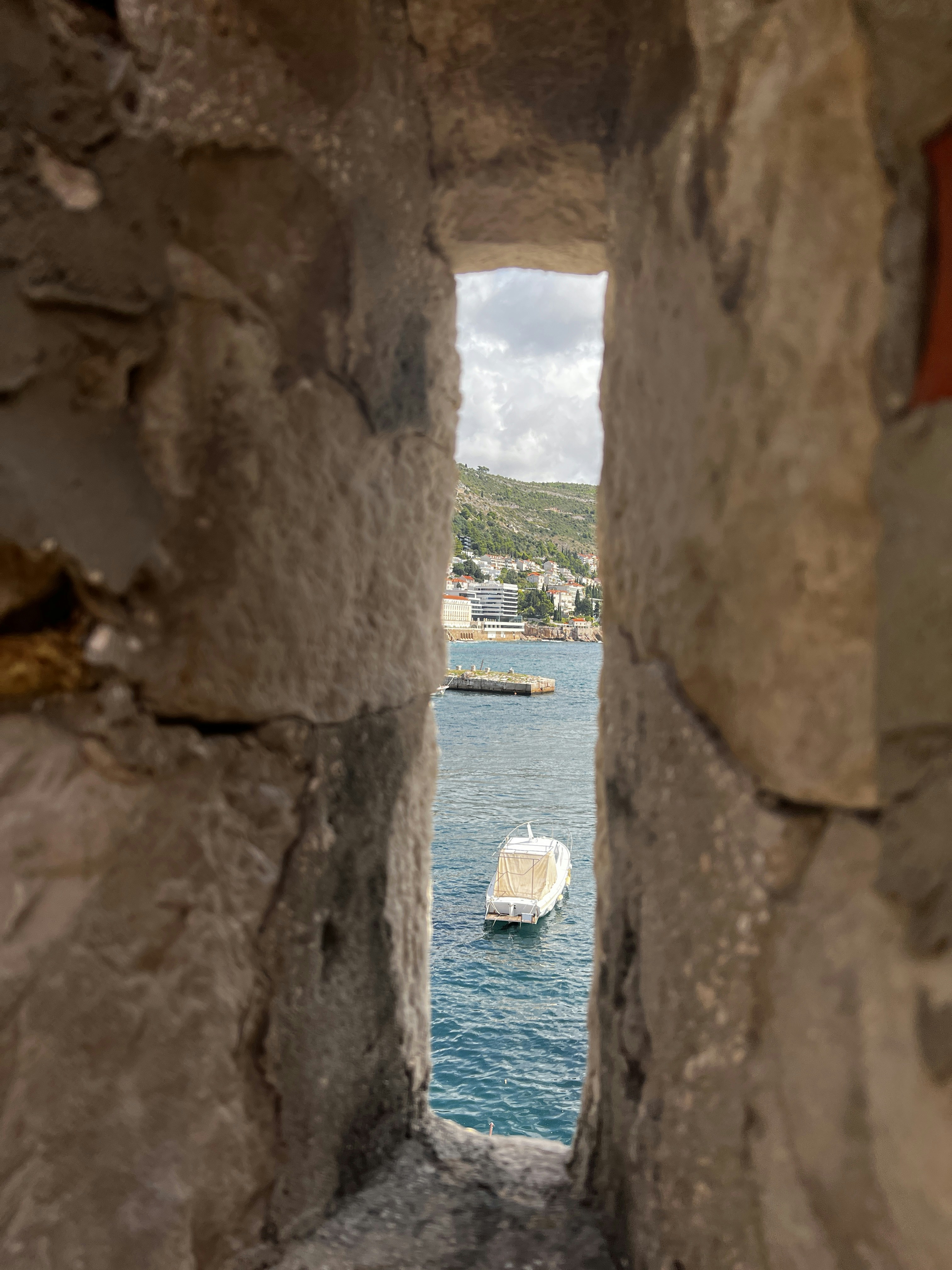 Harbor View Framed by Stone: A Window to the Sea