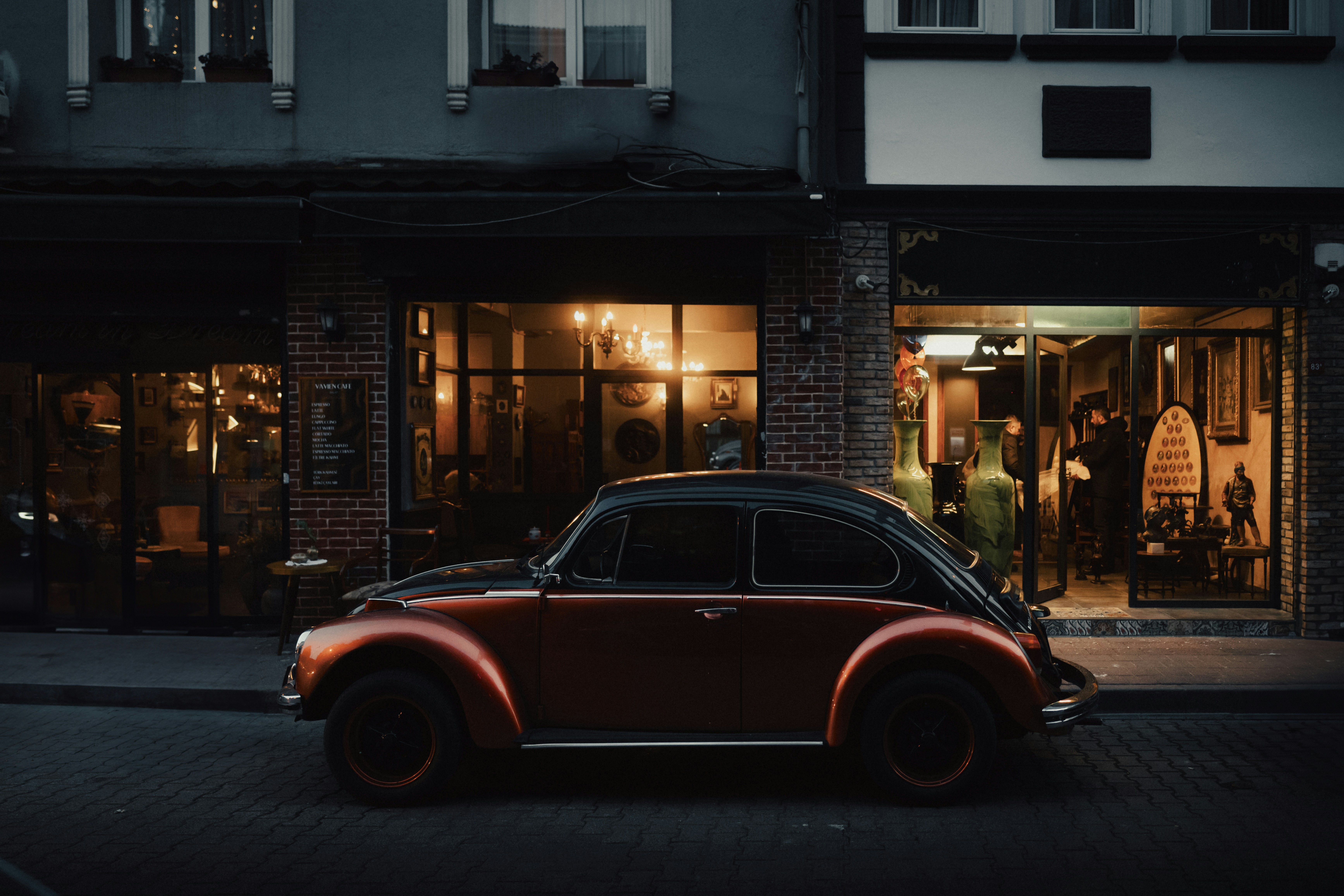 Midnight Velvet: A Classic Car Silhouette Against a City Window