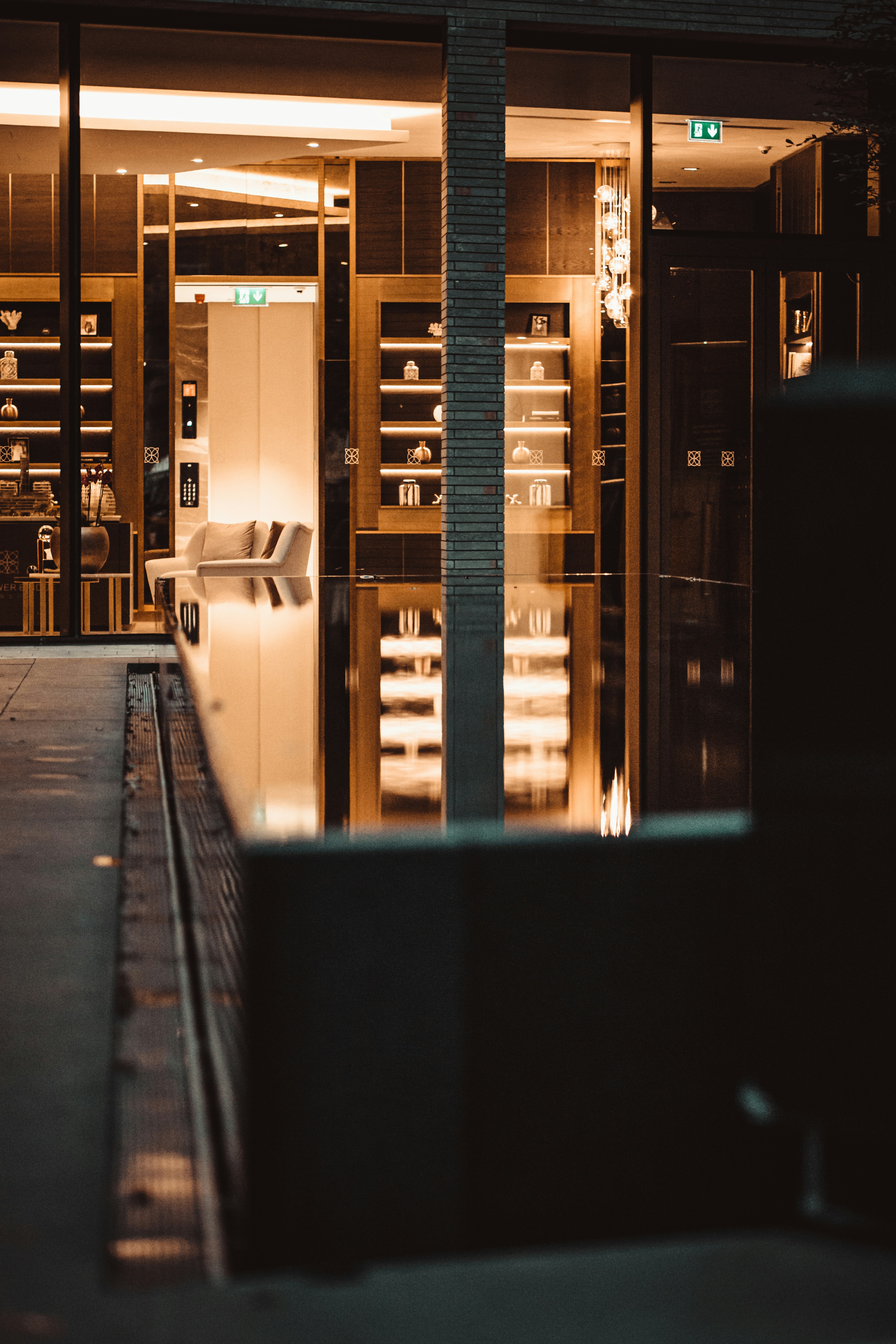 A dimly lit store front with a bench in front of it photo – Free Brown ...