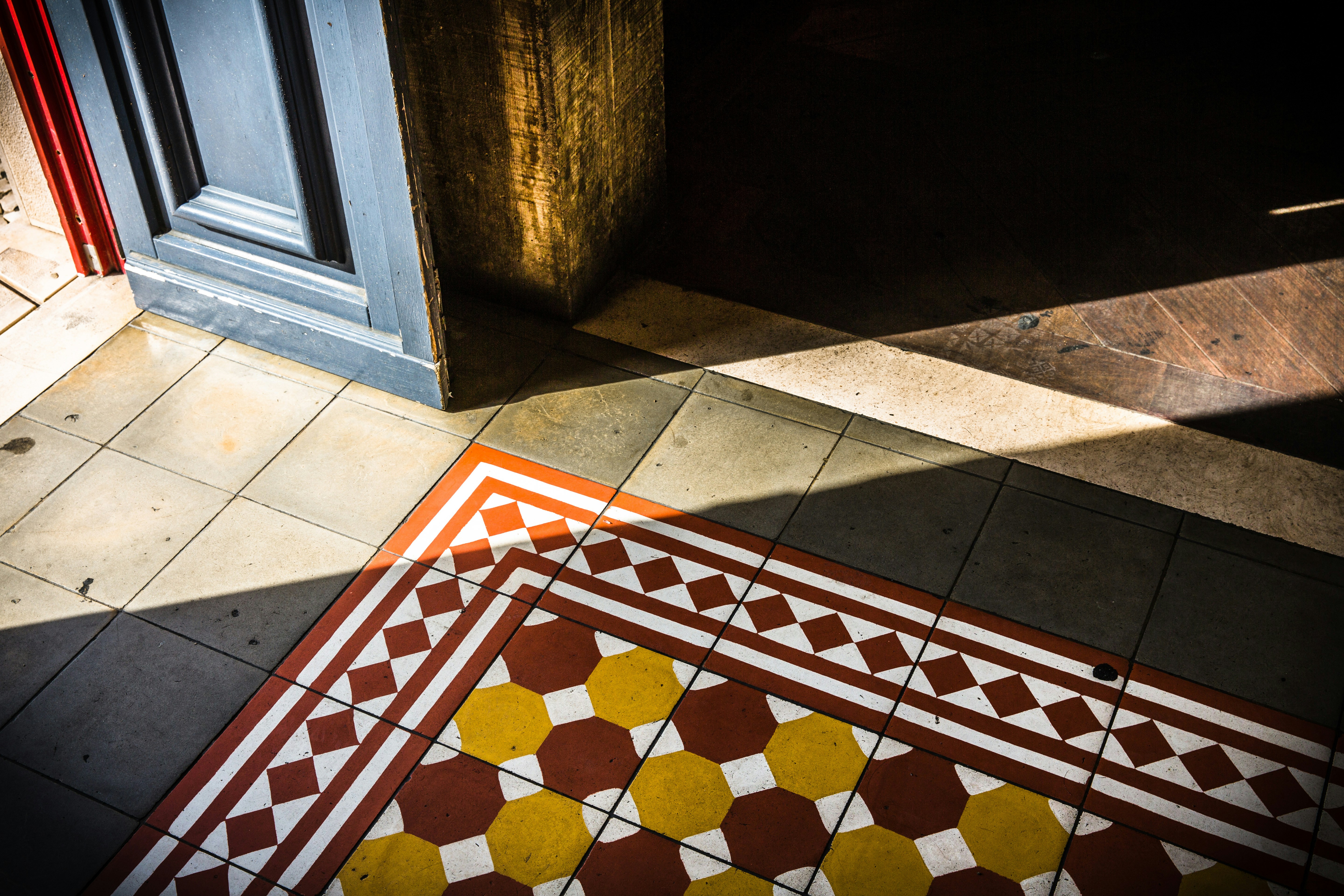 A tiled floor with a door in the background photo – Free Wall Image on ...