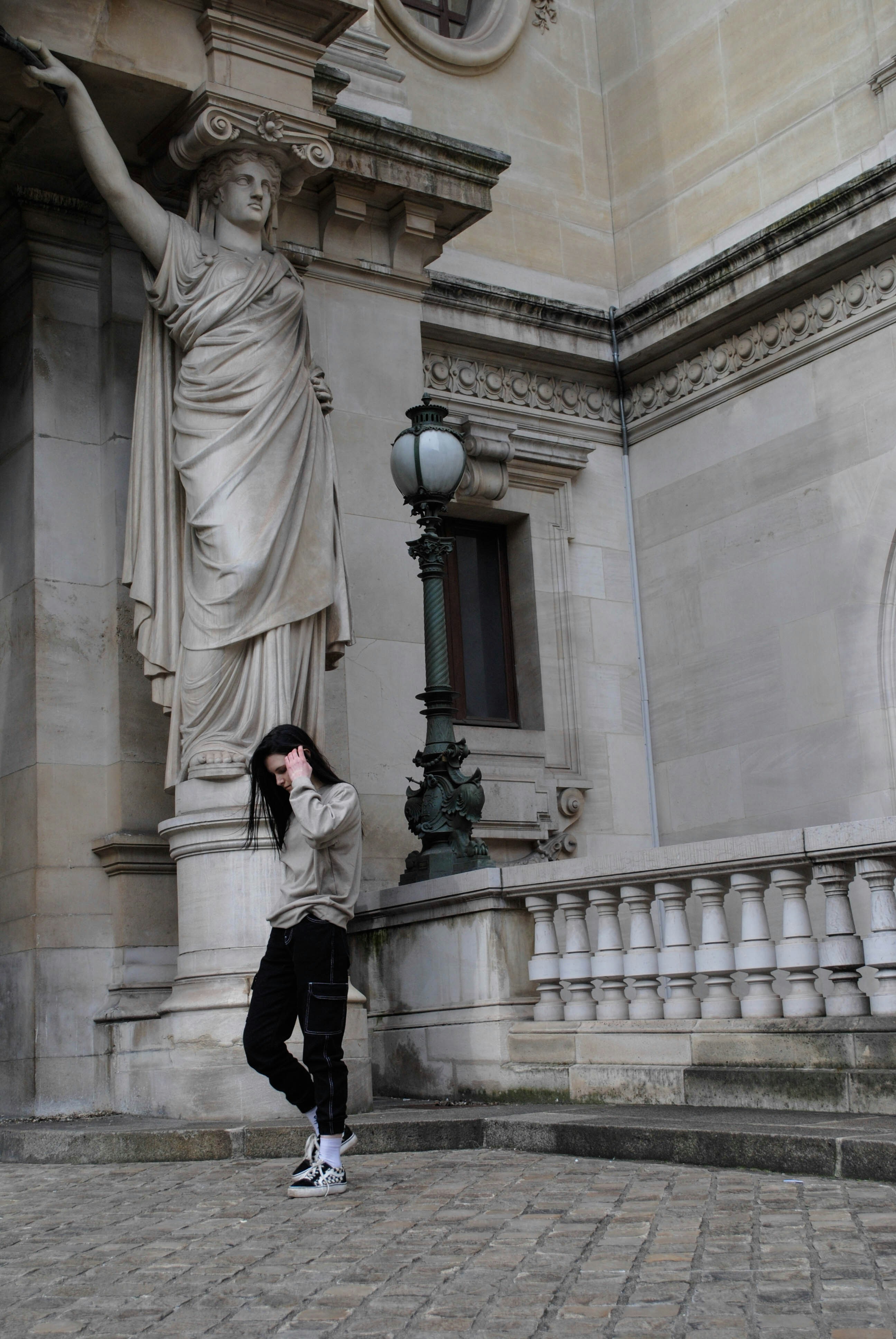 Lean Against Time: A Figure by Marble Facade
