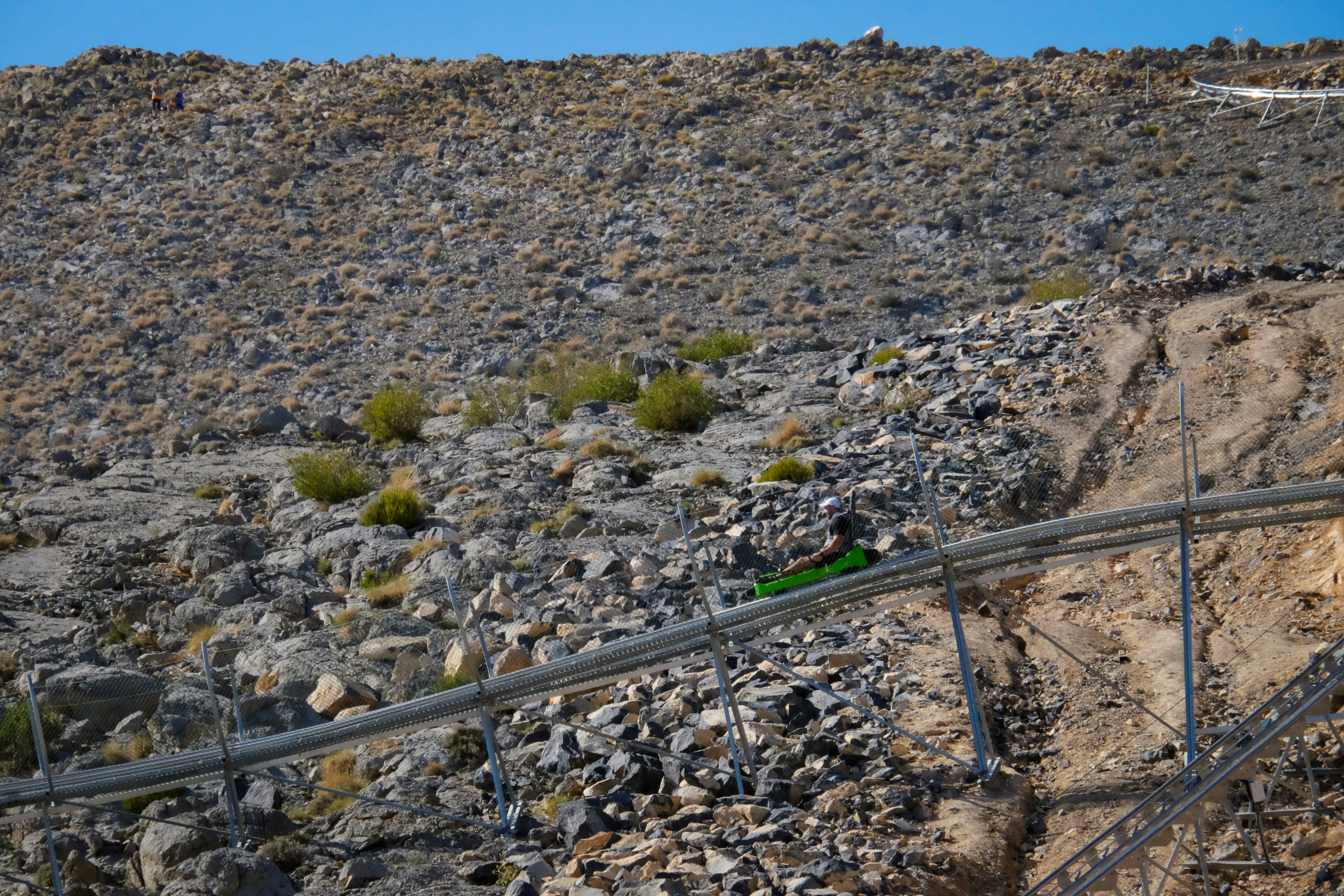 Emerald Pin along a Curved Guardrail on a Scree Slope