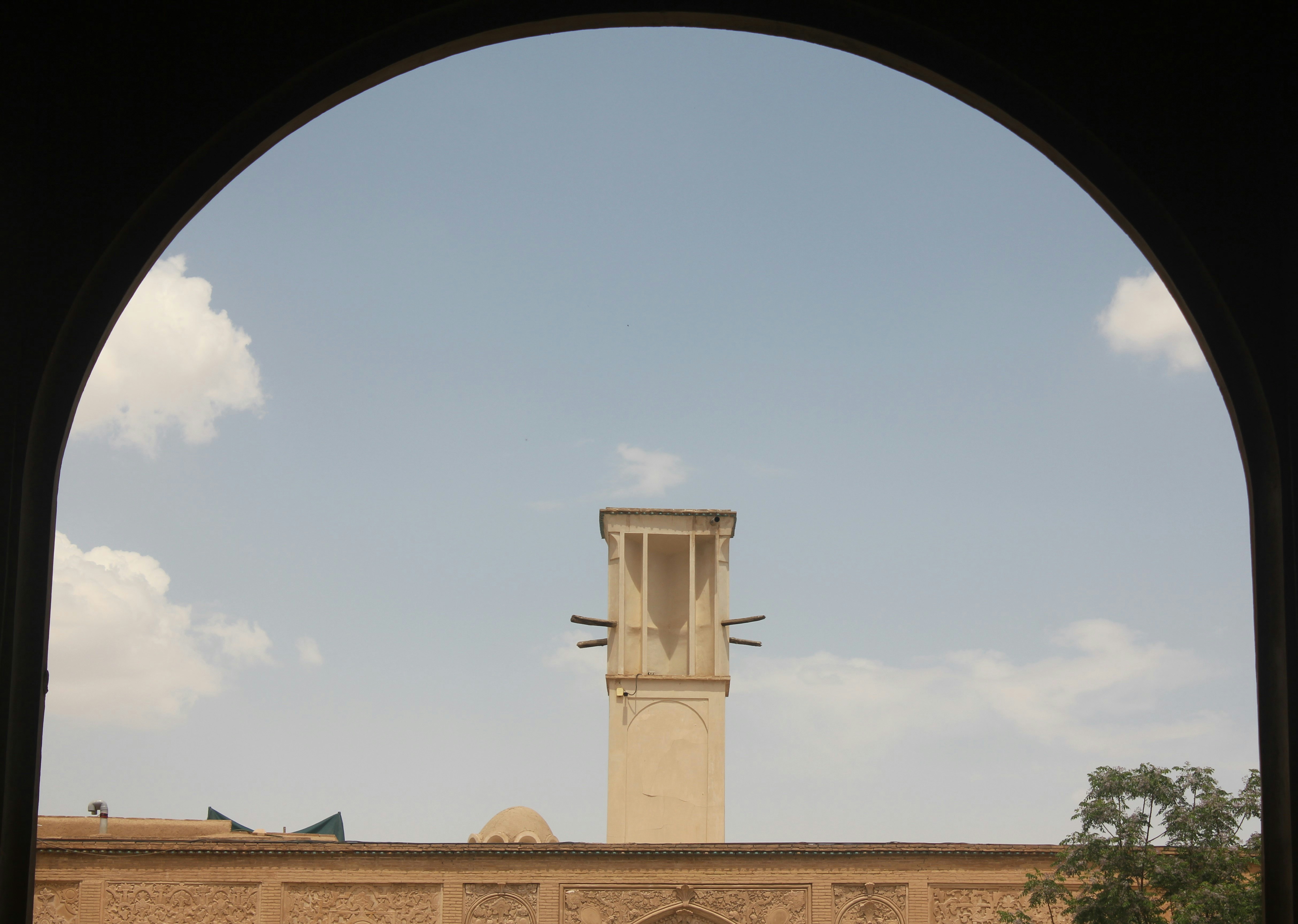 Through the Arch: A Central Tower Rising Against a Clear Sky