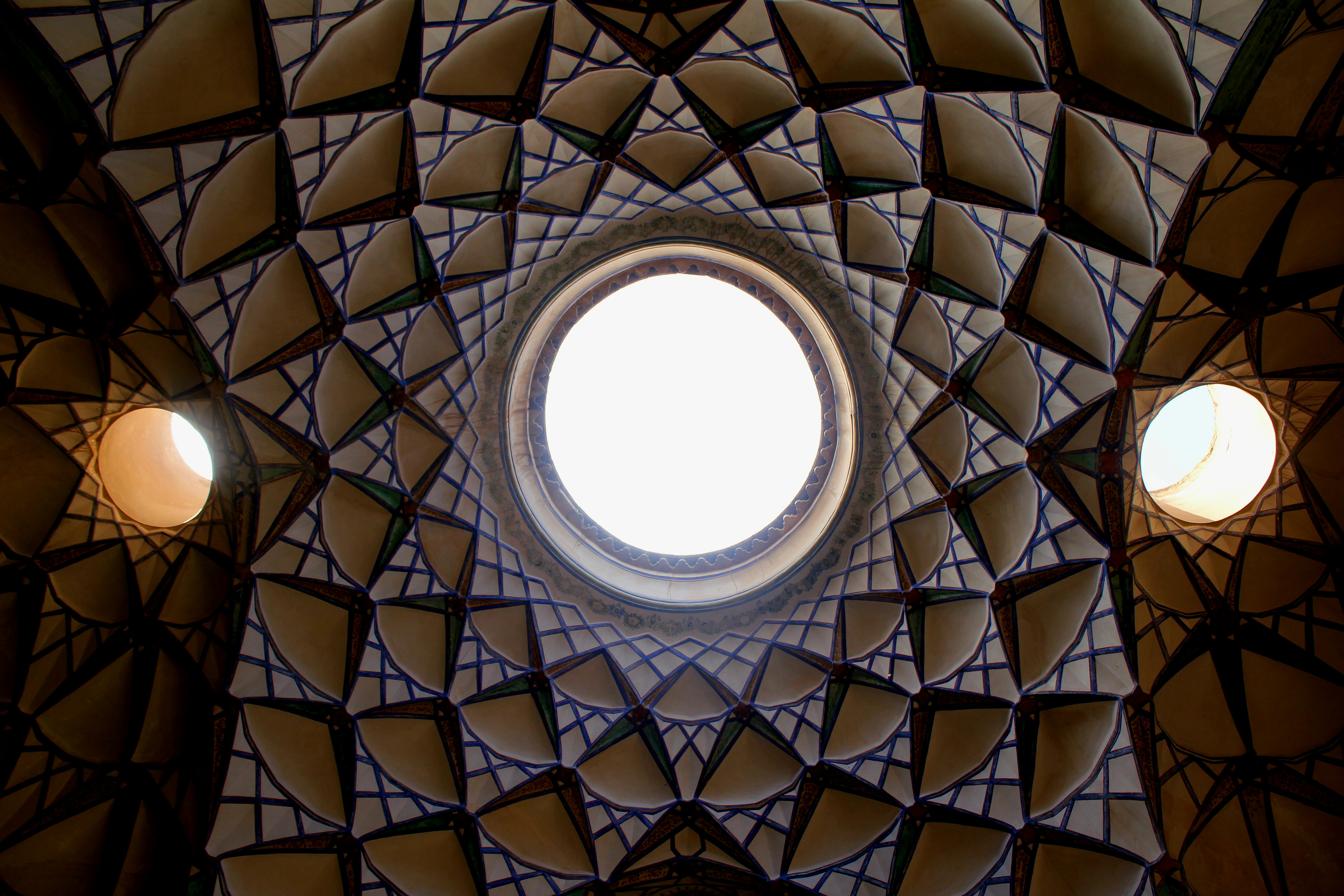 A circular window in the ceiling of a building photo – Free Kashan ...