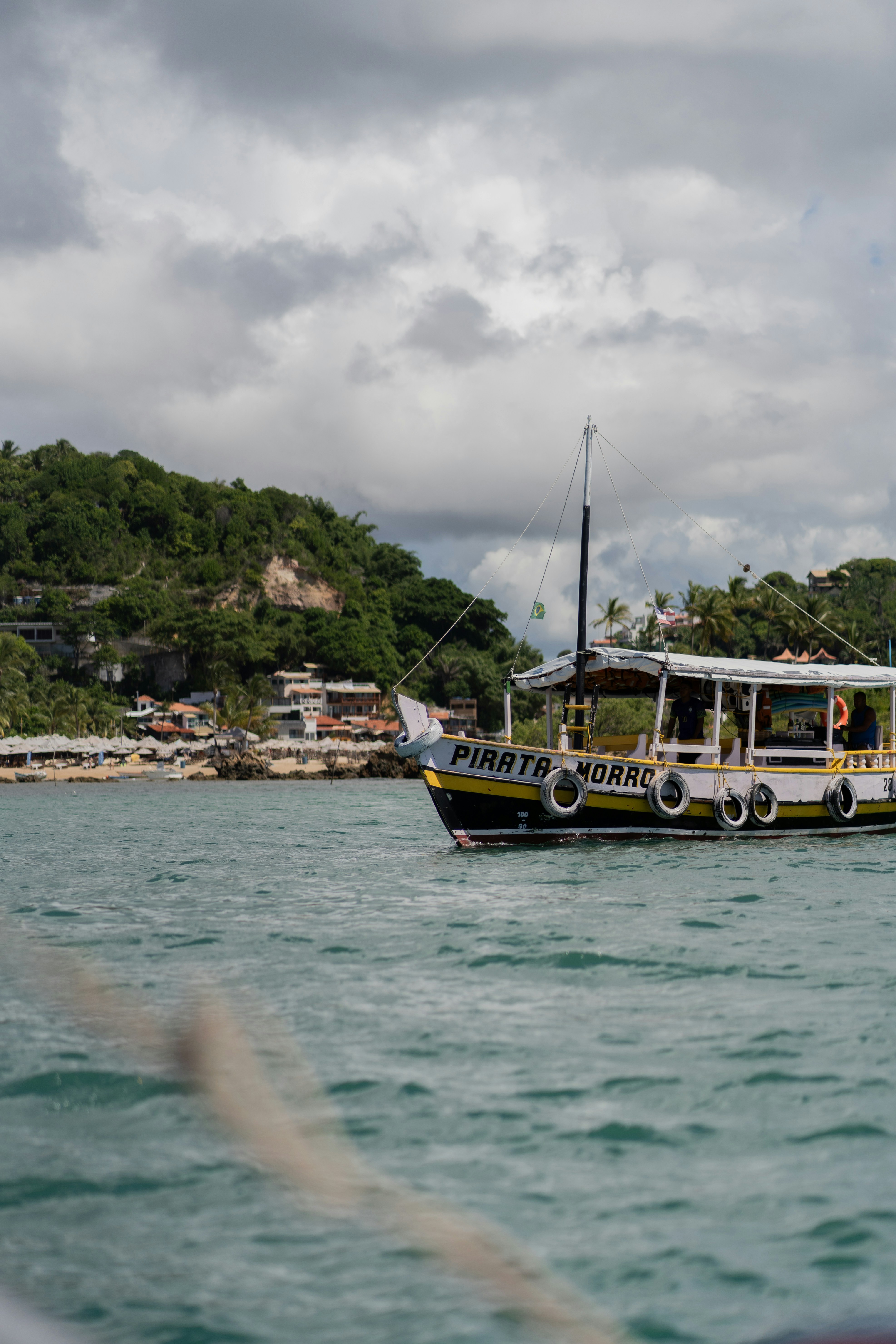Sunlit Boat on turquoise waters near a tropical shore