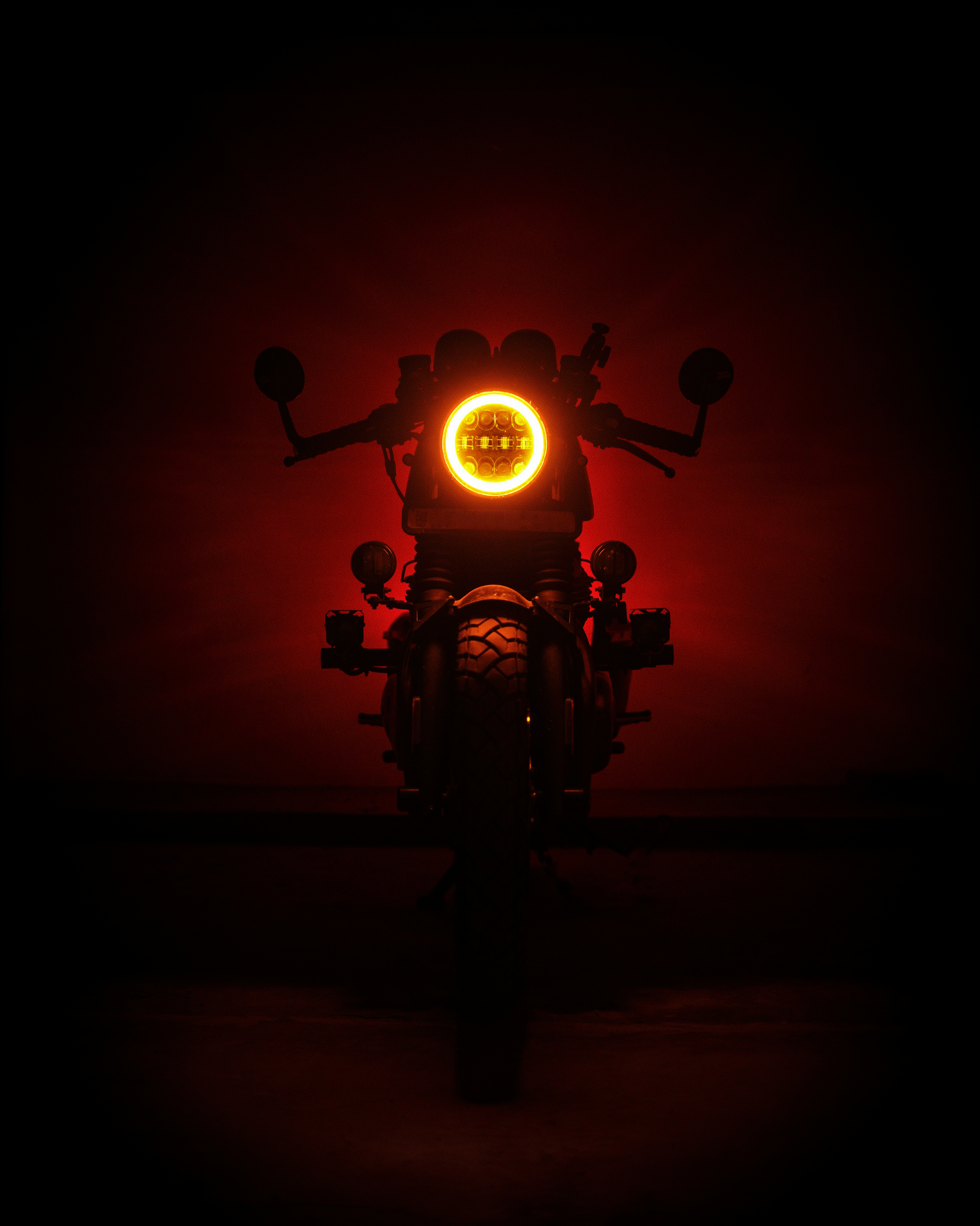 A motorcycle with a red light on it's headlight photo – Free Motor bike ...