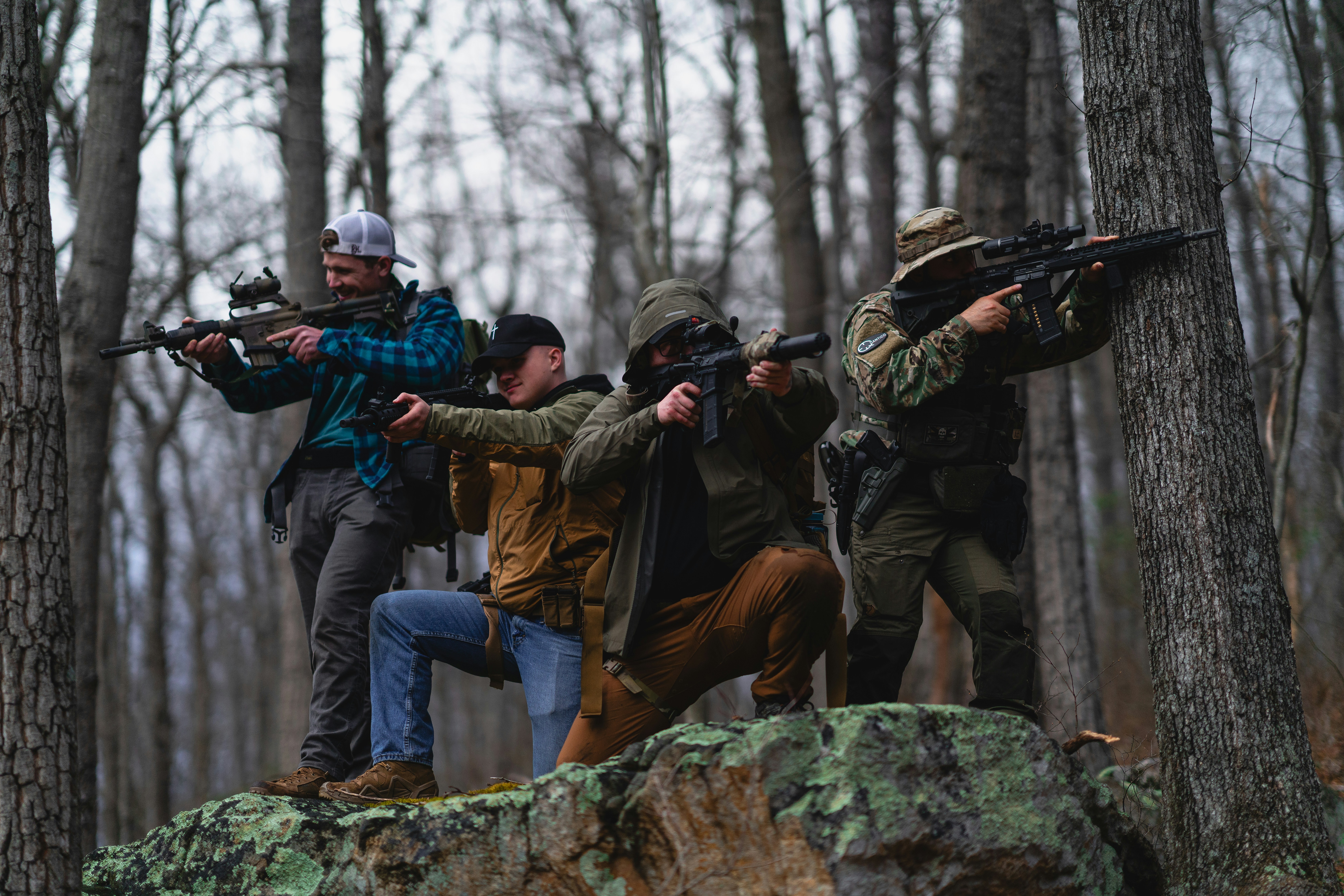 A group of men with guns in the woods photo – Free Gun Image on Unsplash