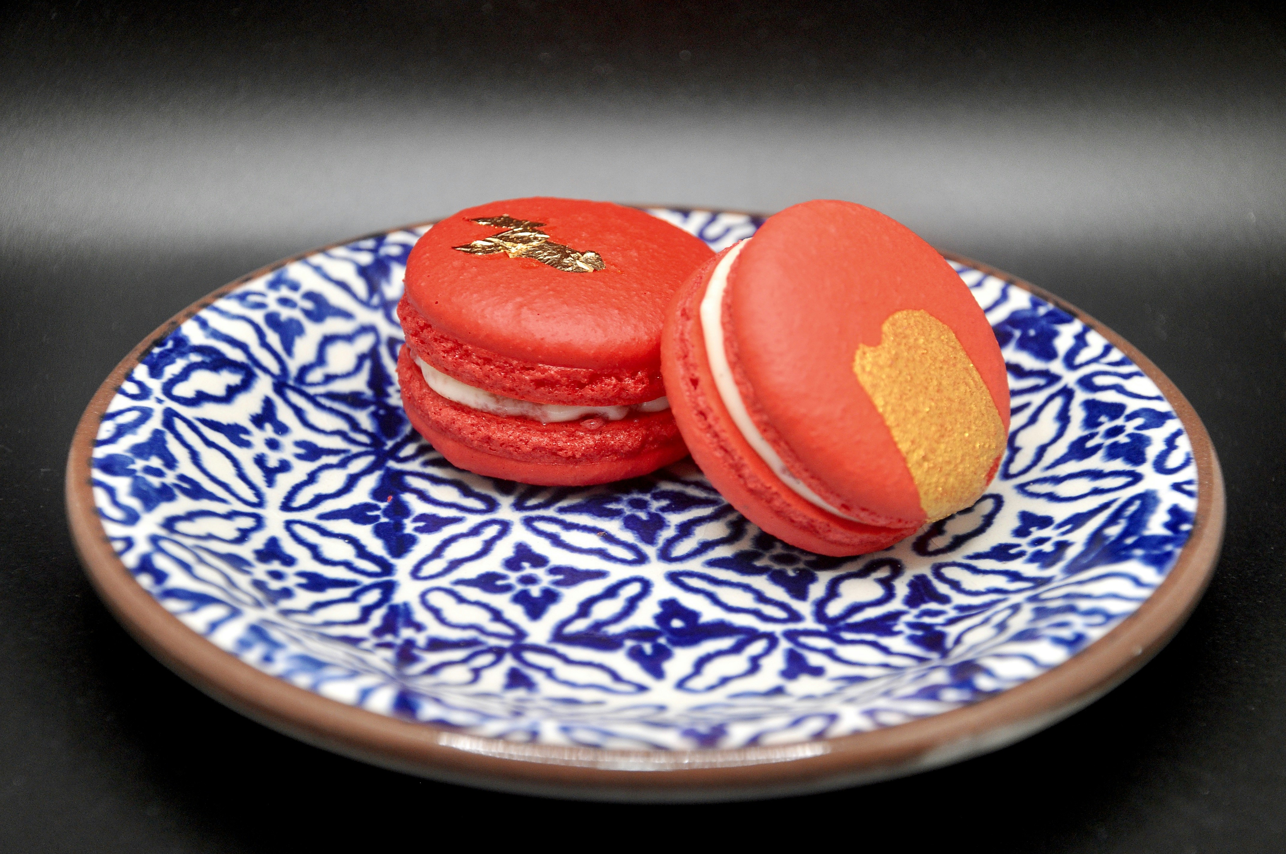 Two red macaroons on a blue and white plate photo – Free Sweets Image ...