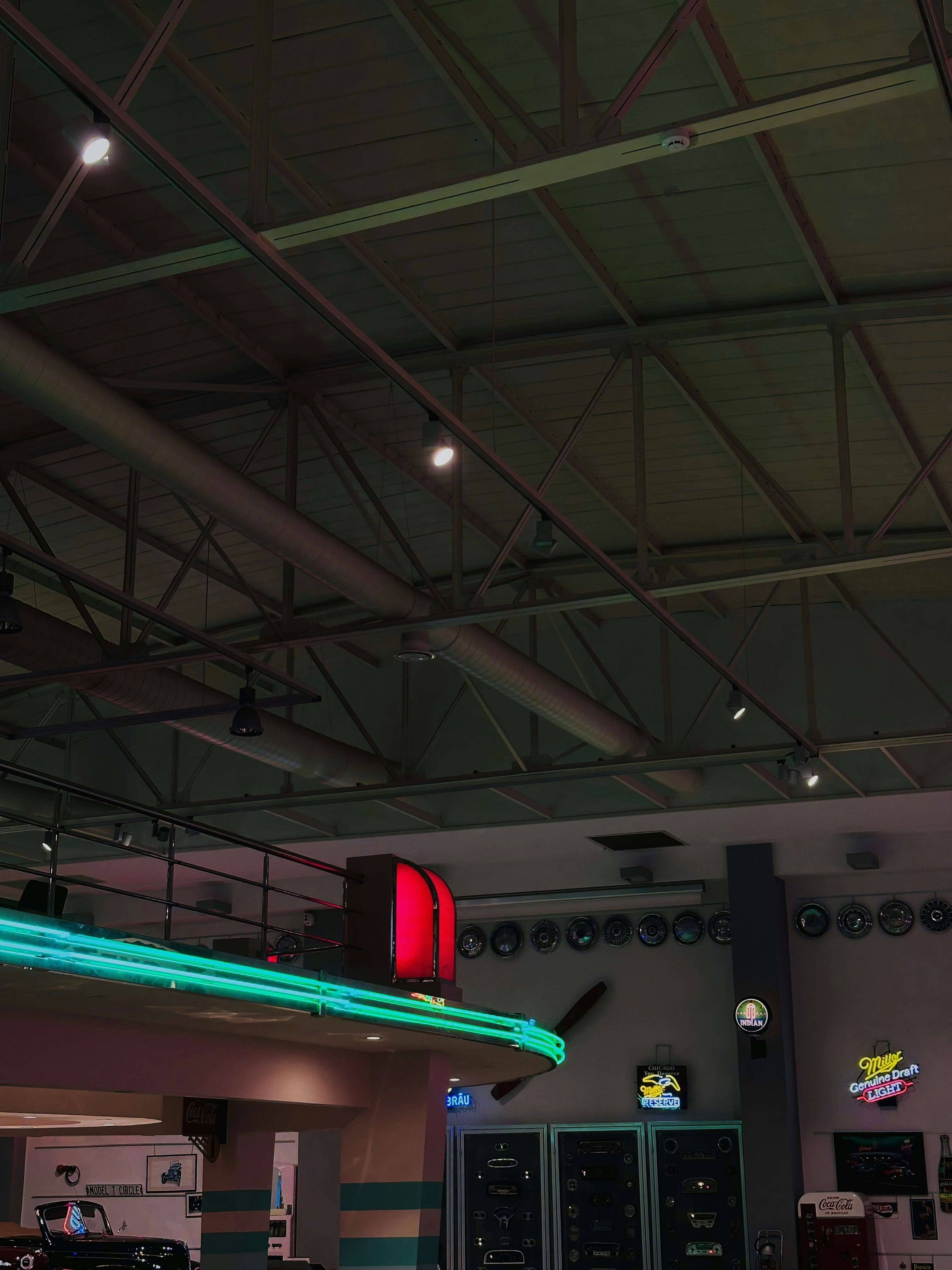 Neon Cyan Curve Illuminates a Retro Arcade Interior