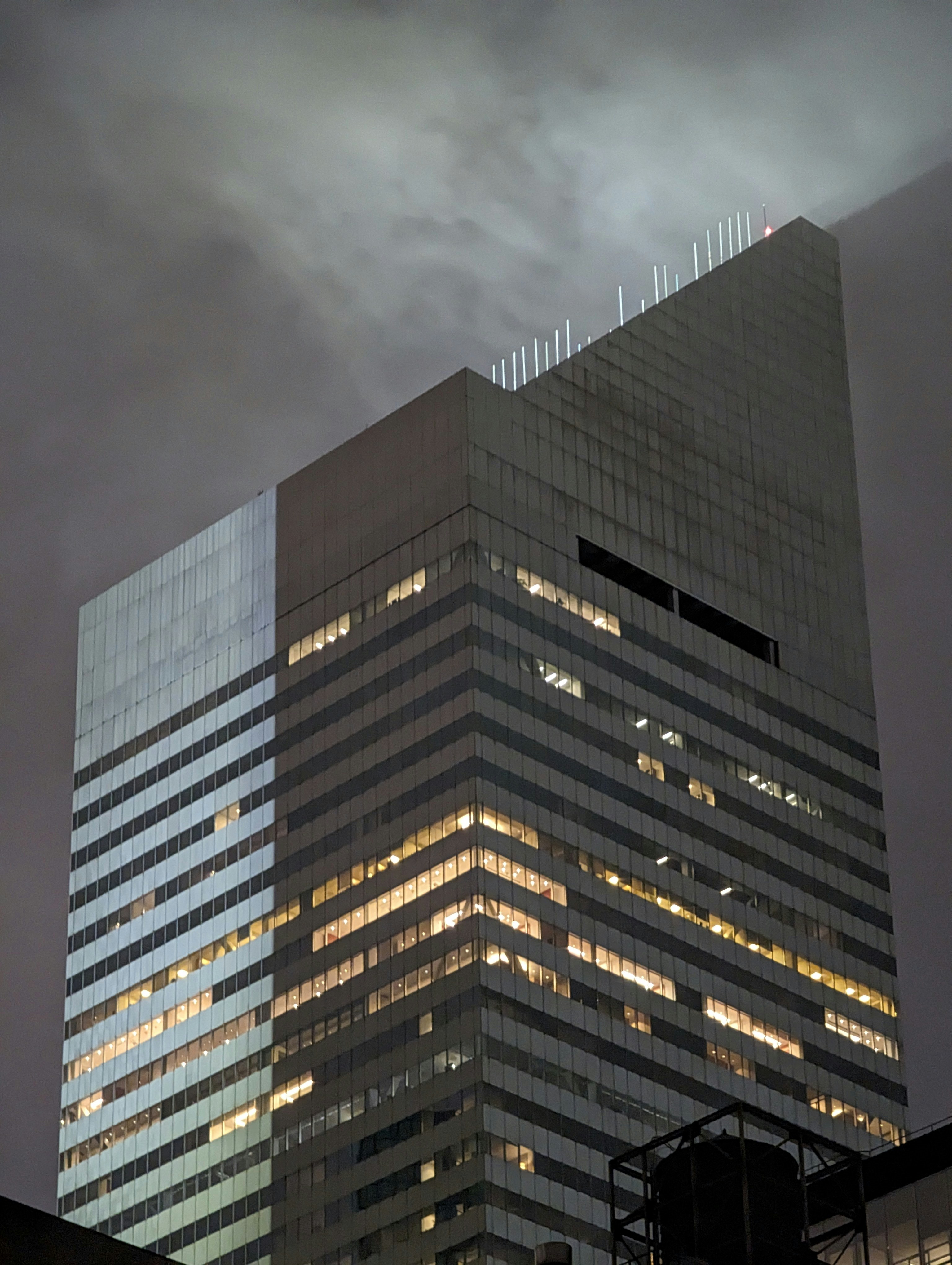 Diagonals of Light on a Nighttime Glass Tower