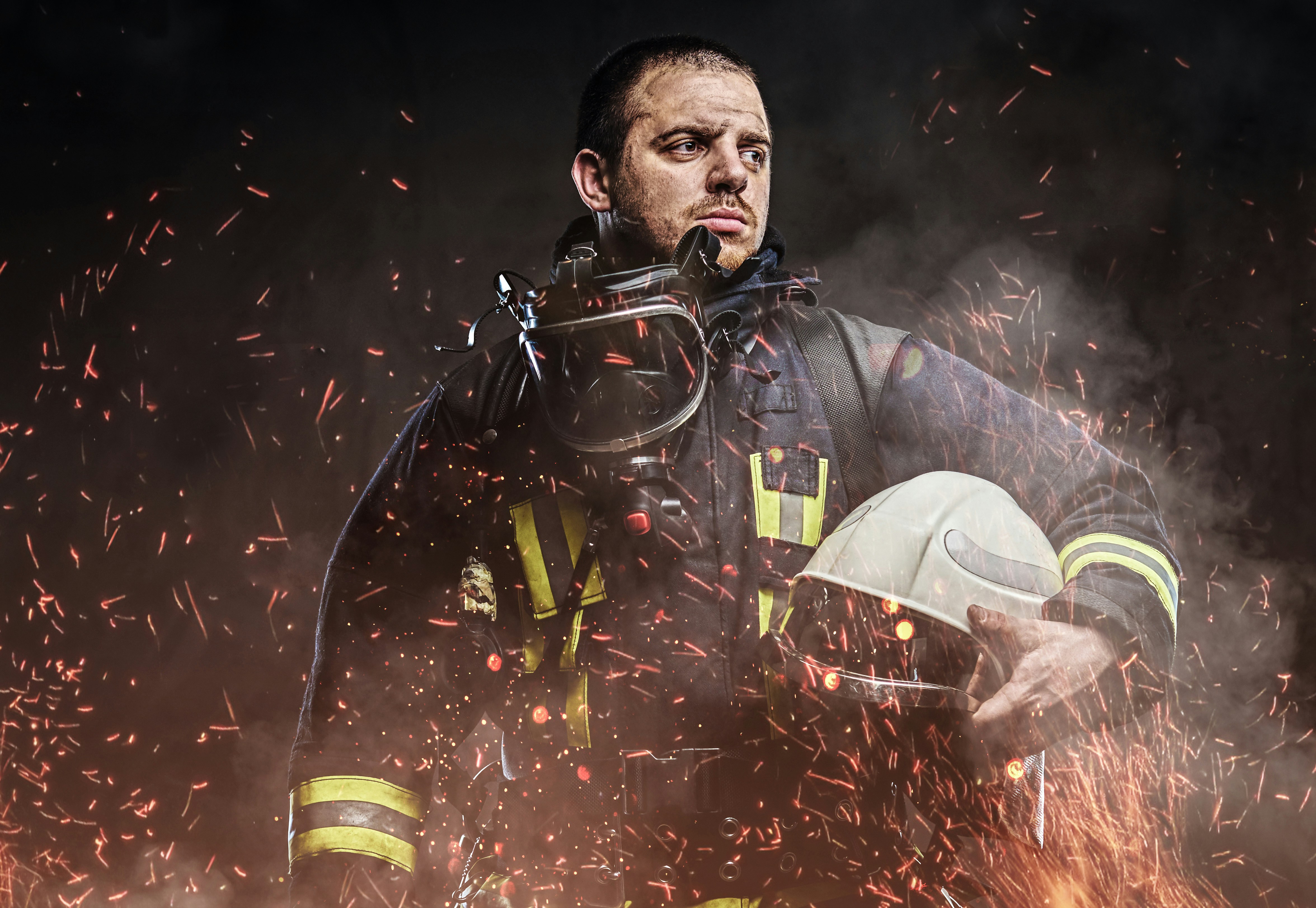 A man in a firefighter's uniform holding a fire extinguisher photo ...