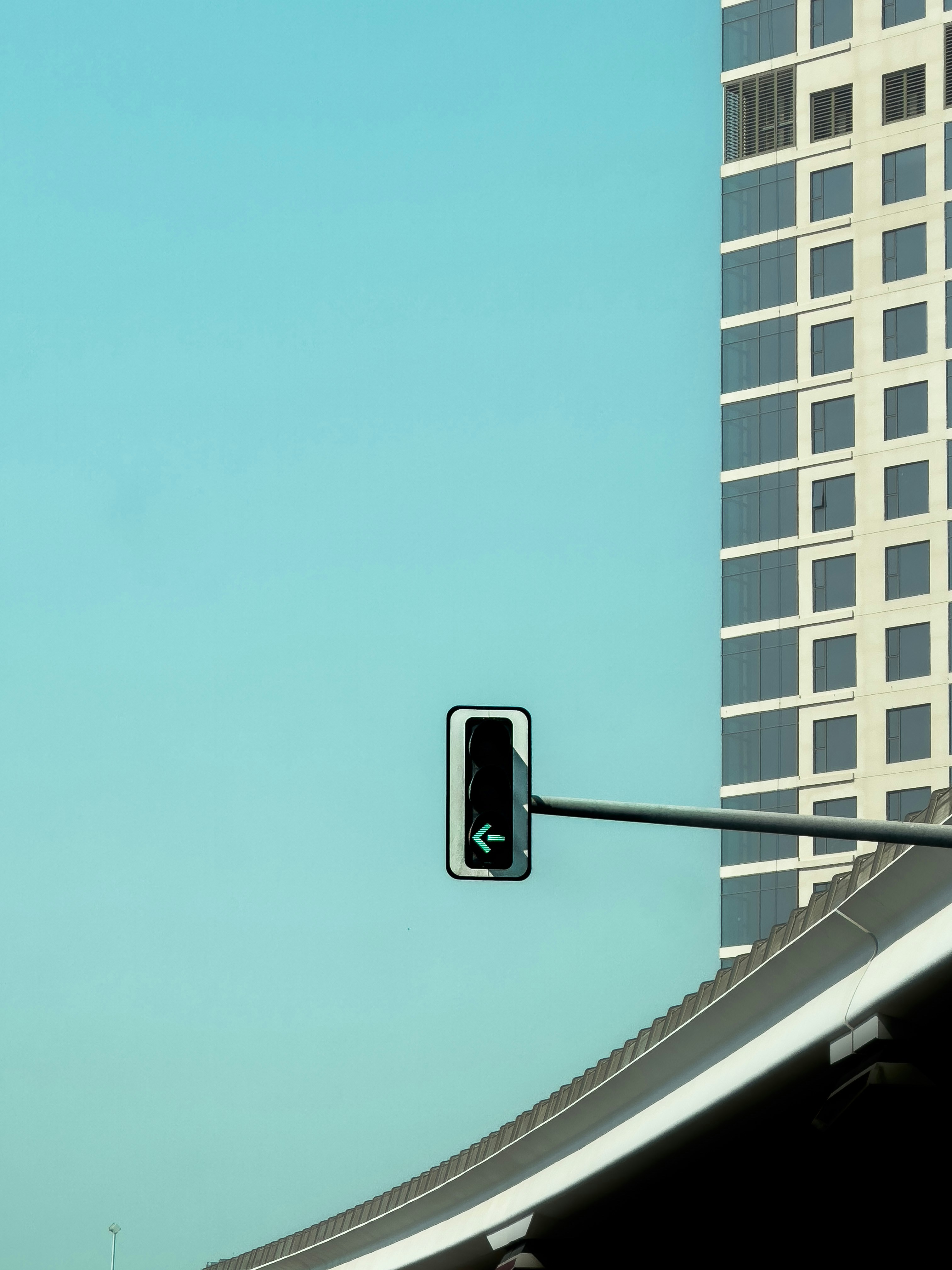 A traffic light with a building in the background photo – Free Light ...
