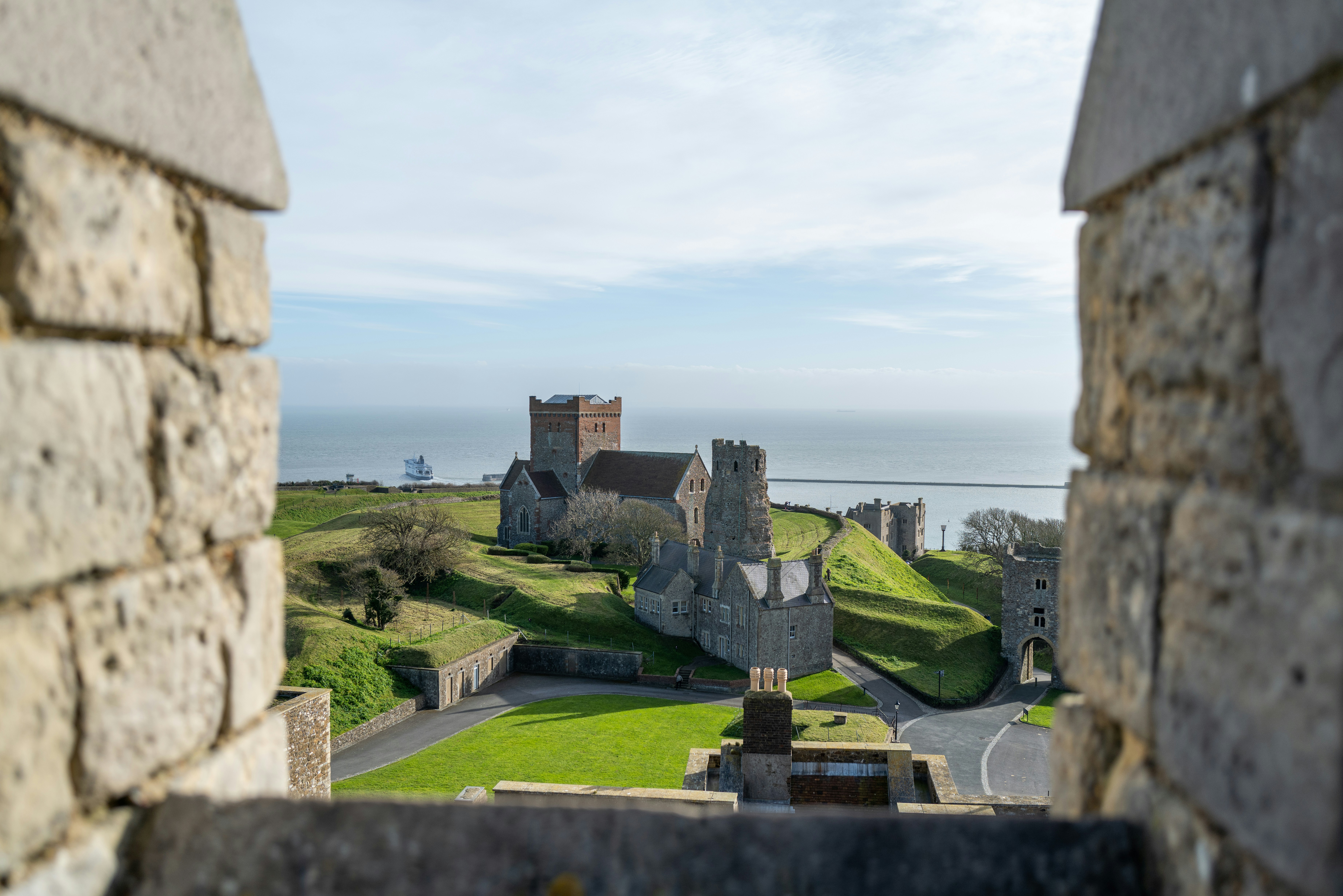 A view of a castle through a window photo – Free Uk Image on Unsplash